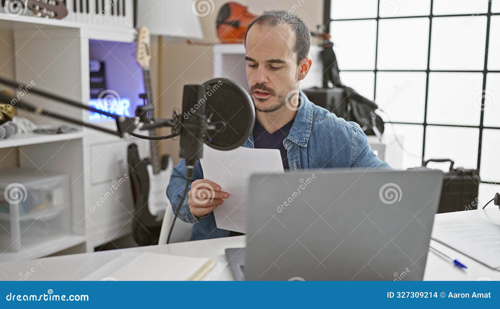 Bald Hispanic Man with Beard Recording in a Modern Studio Using ...