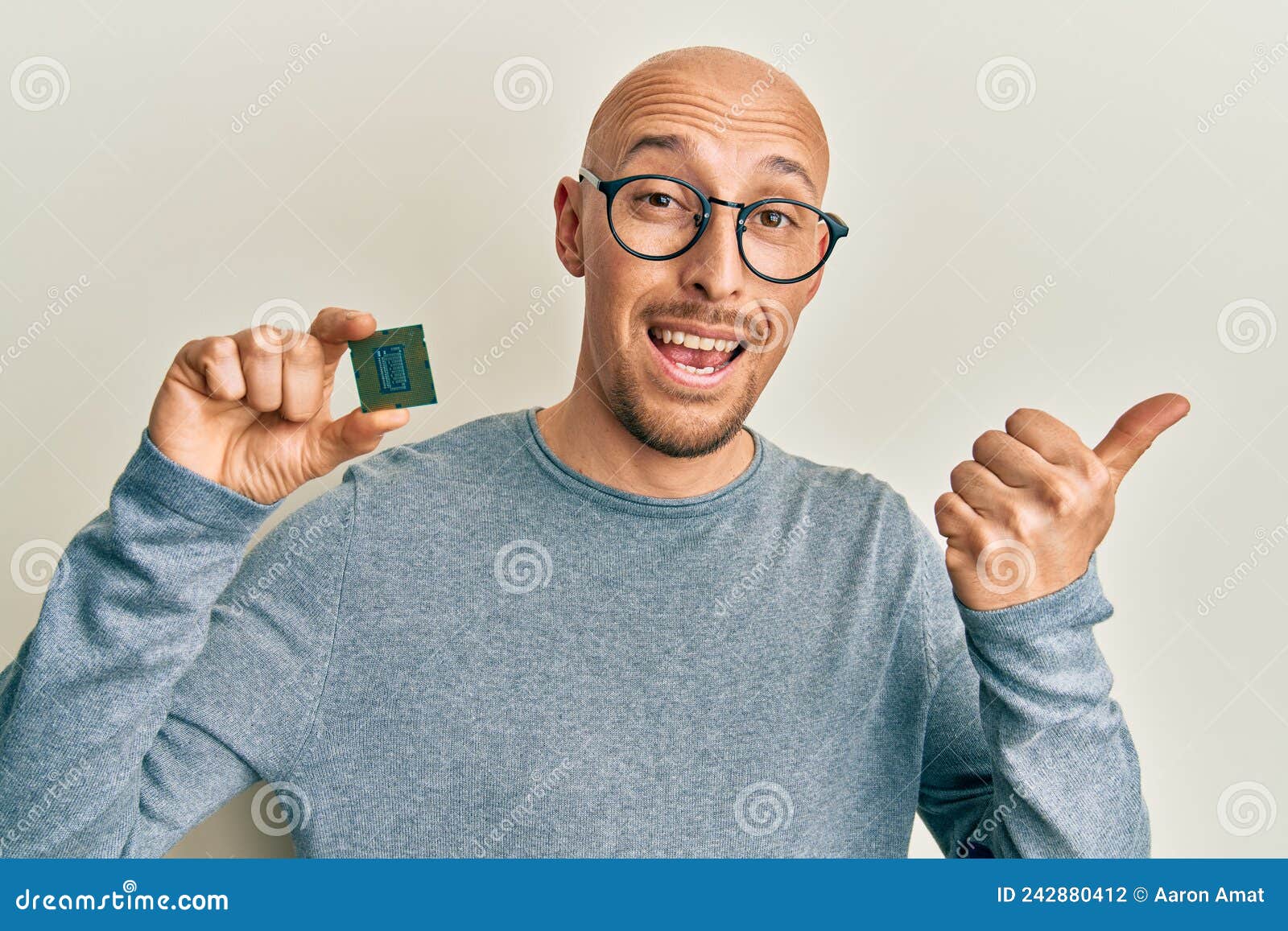Bald Man with Beard Holding Cpu Computer Processor Pointing Thumb Up To ...
