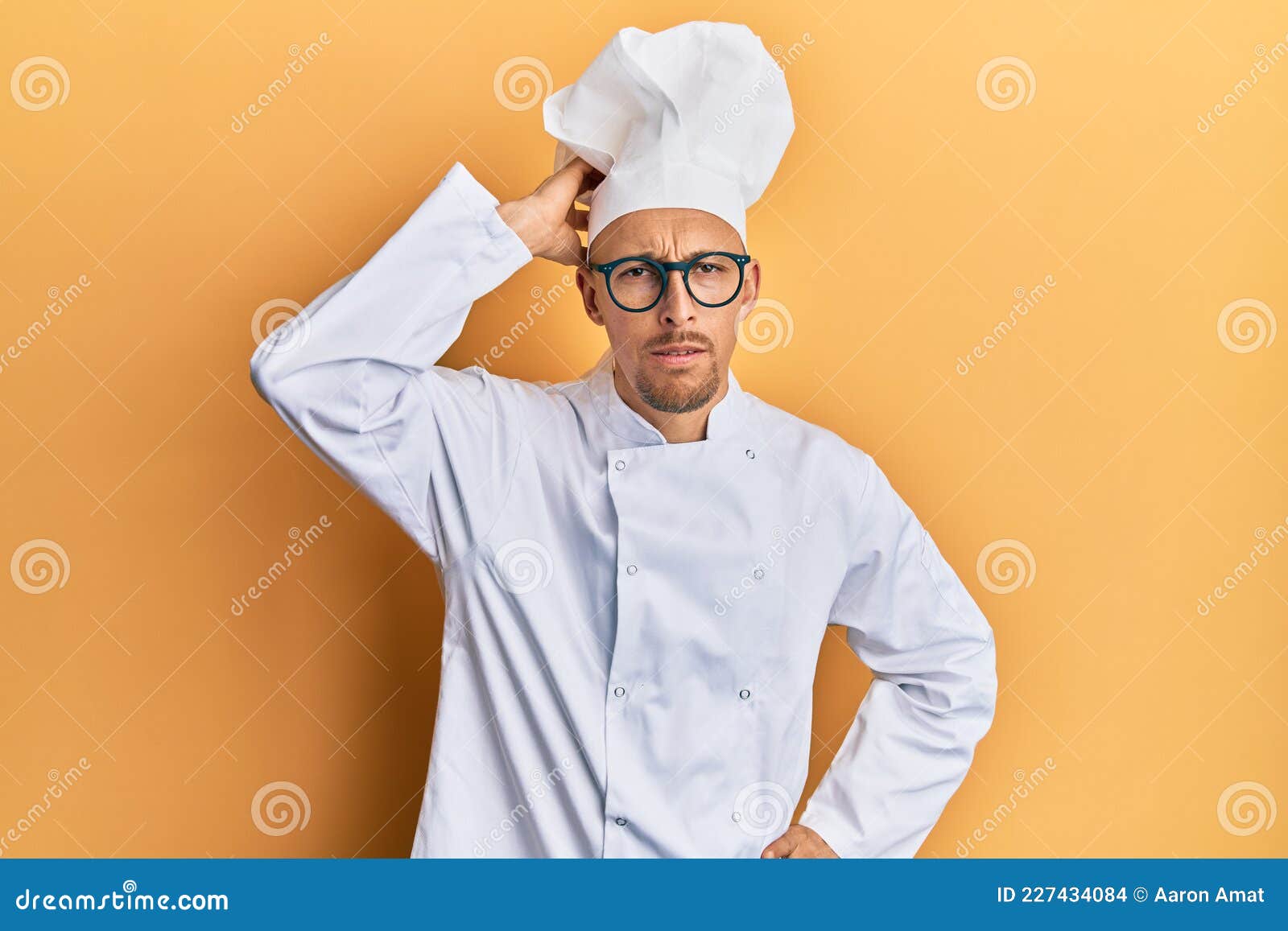 Bald Man with Beard Wearing Professional Cook Uniform Confuse and ...