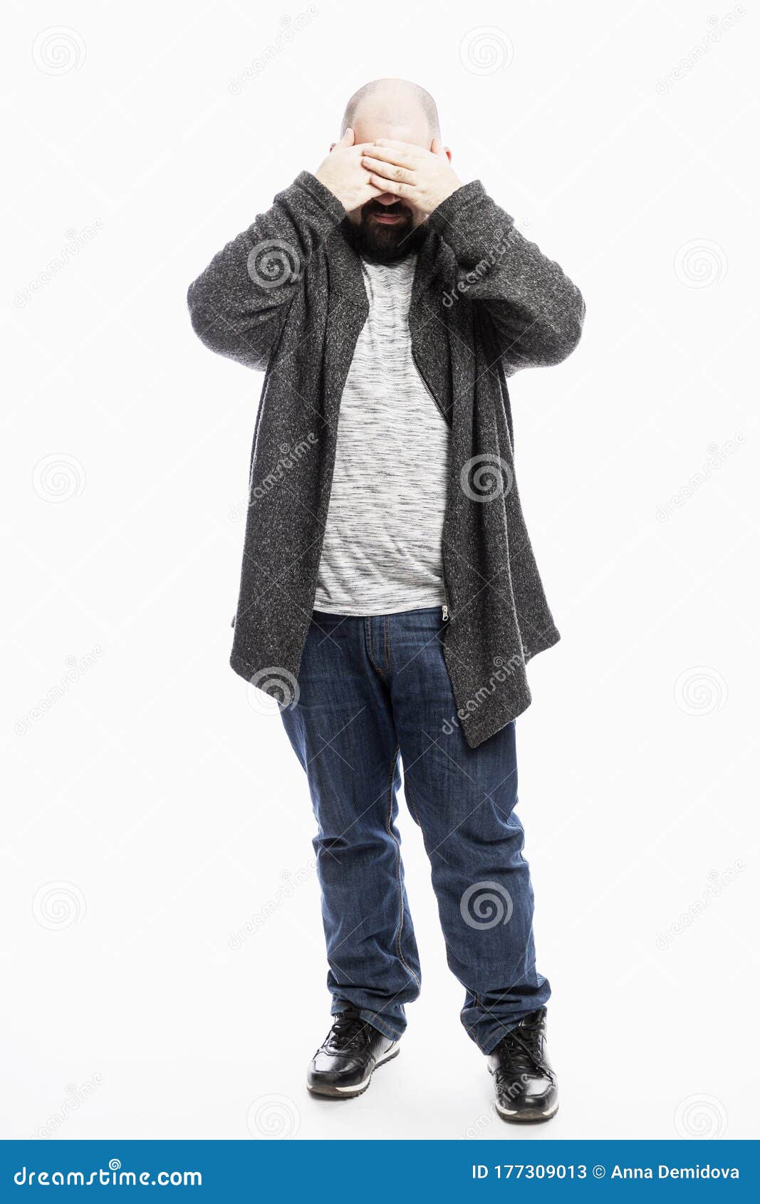 A Bald Man in Jeans Covered His Face with His Hands. Full Height. White ...
