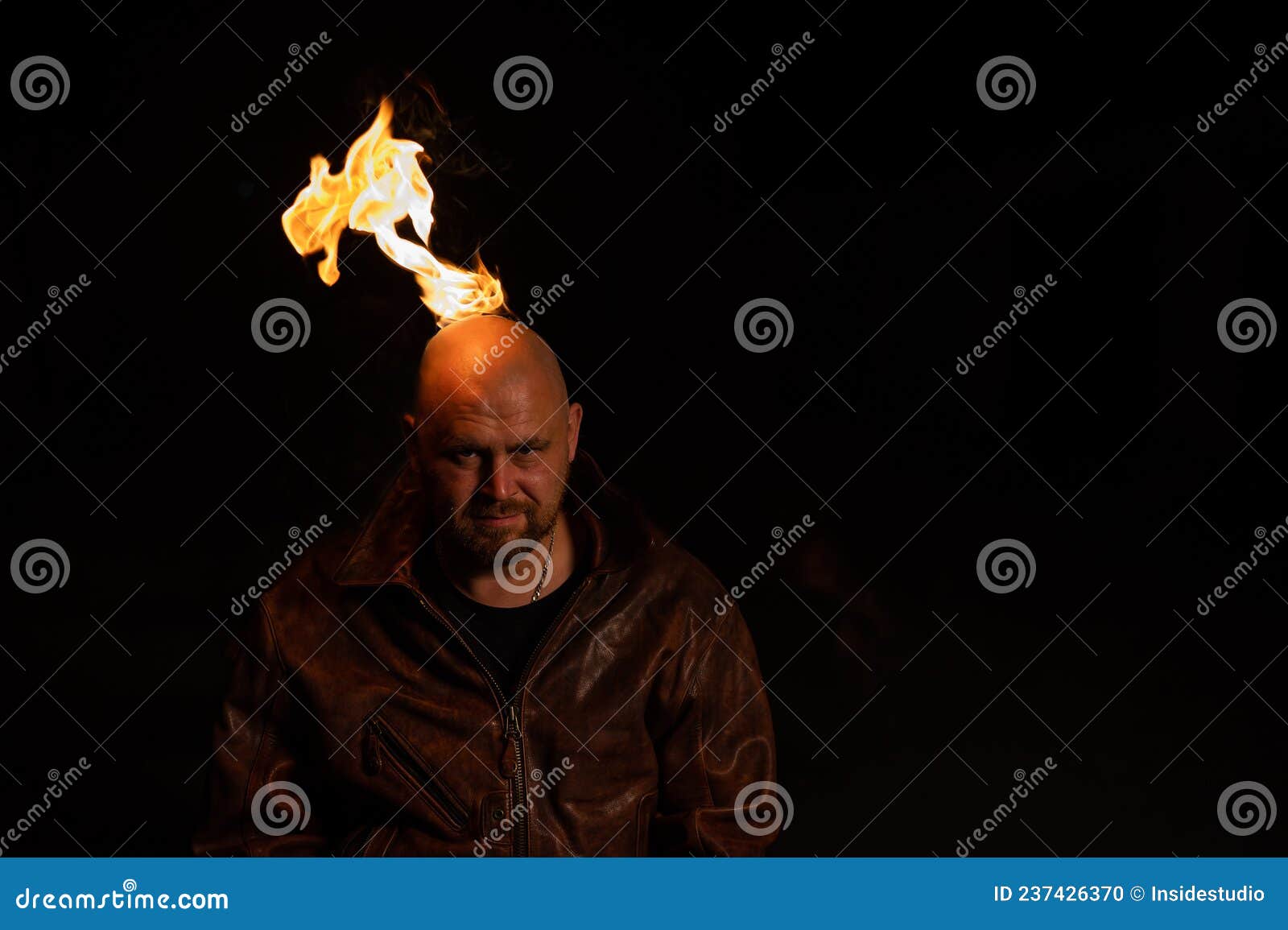 A Bald Man in a Leather Jacket with a Burning Head Grins. Stock Photo ...