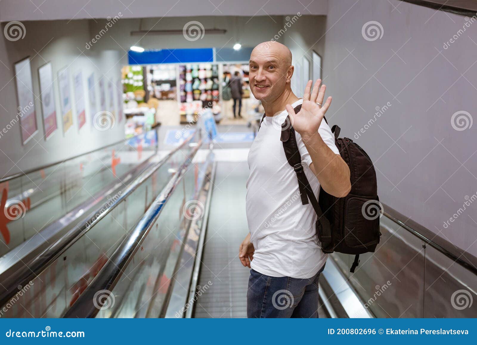 Bald Man Walking Down the Escalator with a Backpack Stock Photo - Image ...
