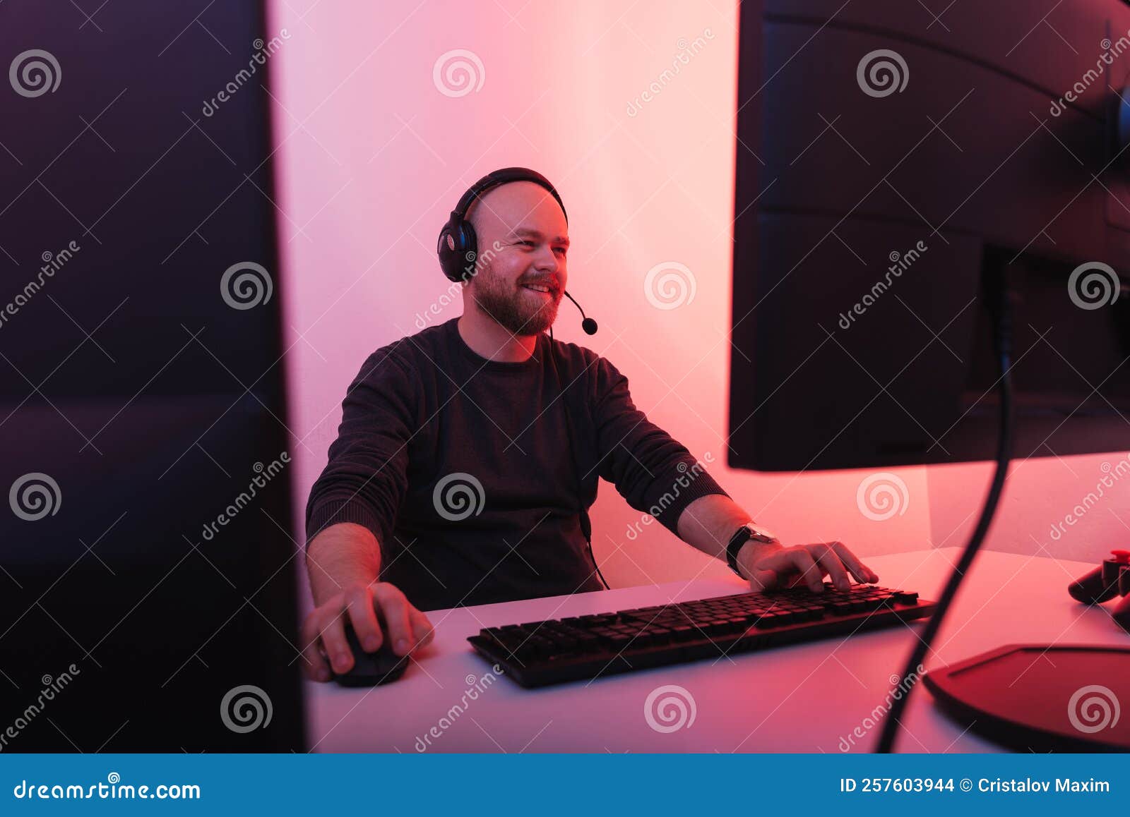 Bald Man Wearing Headset is Sitting and Playing or Working at the ...
