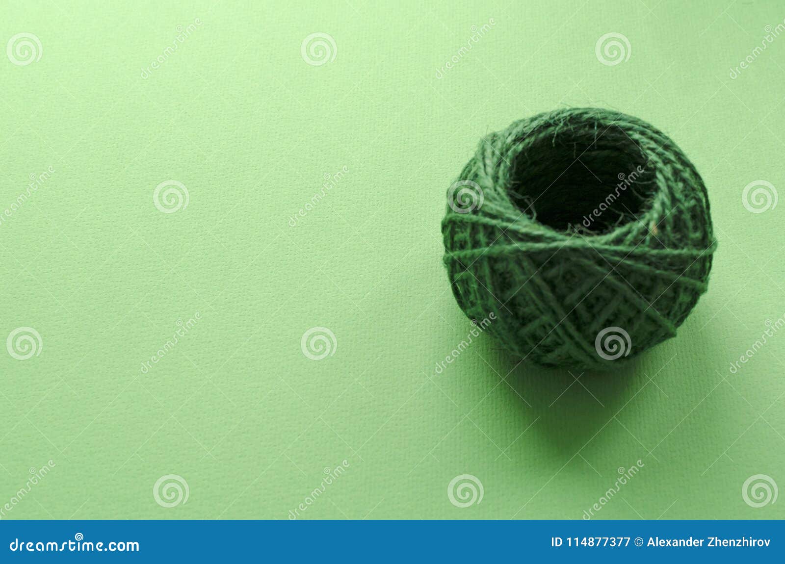 Ball of Green Threads on Green Paper Background Stock Image - Image of ...