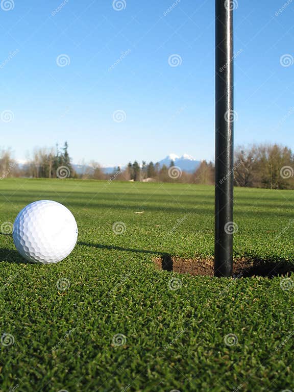 Ball beside hole stock photo. Image of mountain, trees - 4406640