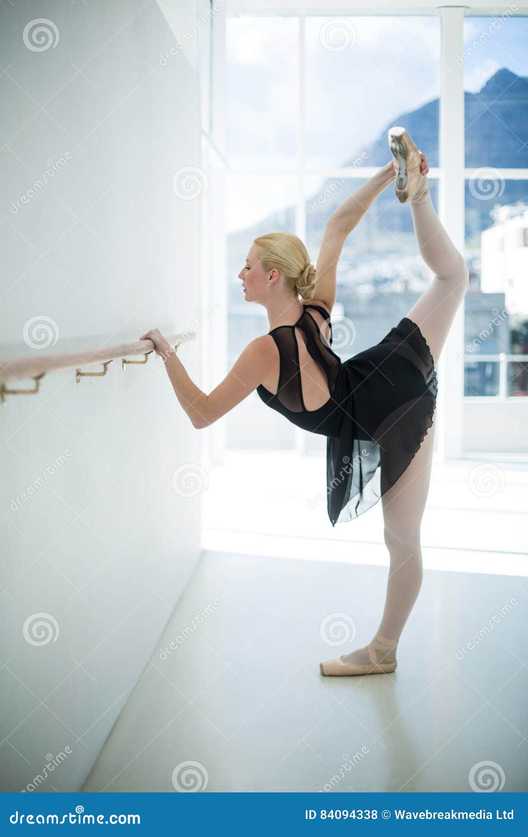 Ballerina Stretching at Barre Stock Photo - Image of barre, holding ...