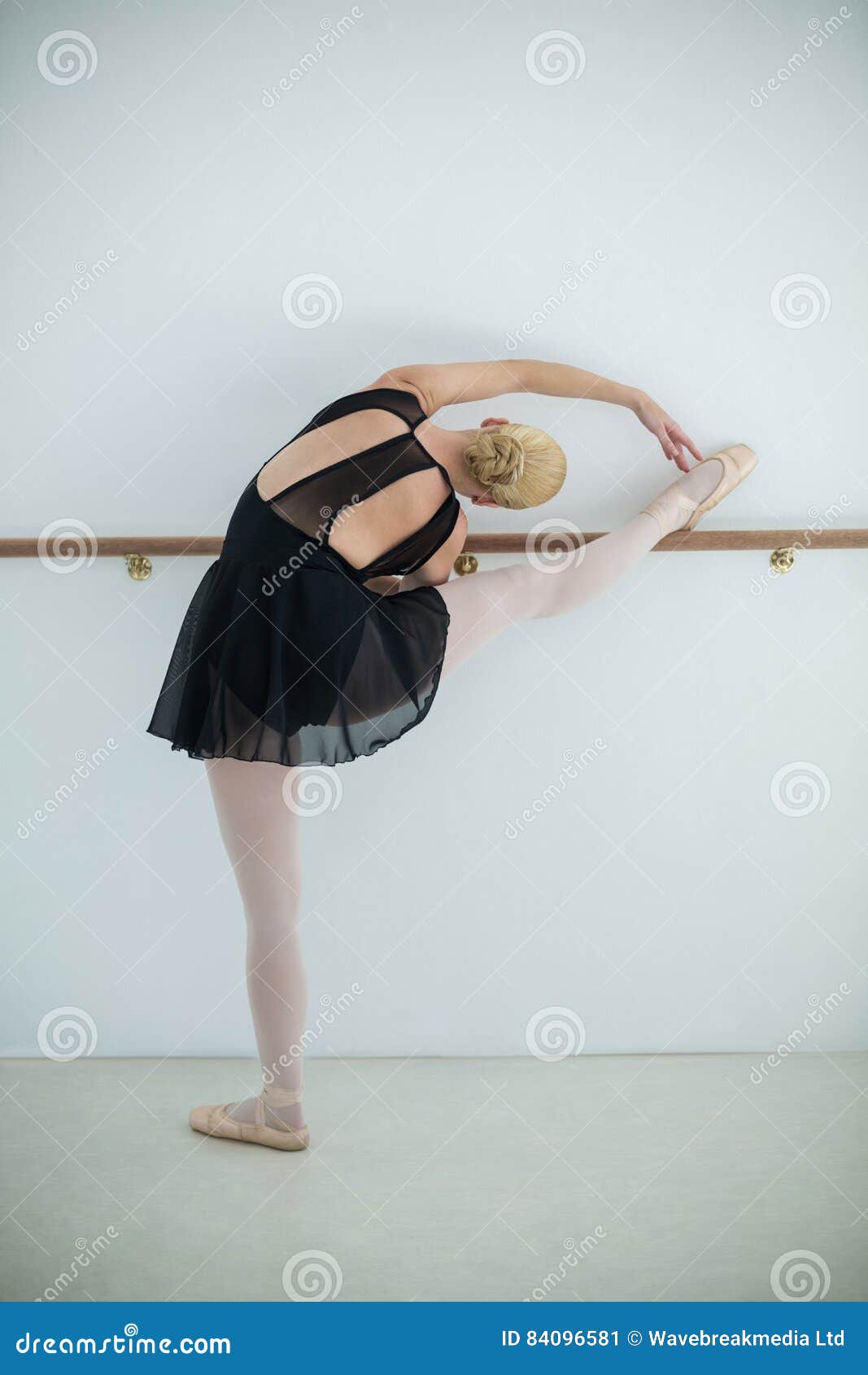 Ballerina Stretching on a Barre while Practicing Ballet Dance Stock ...