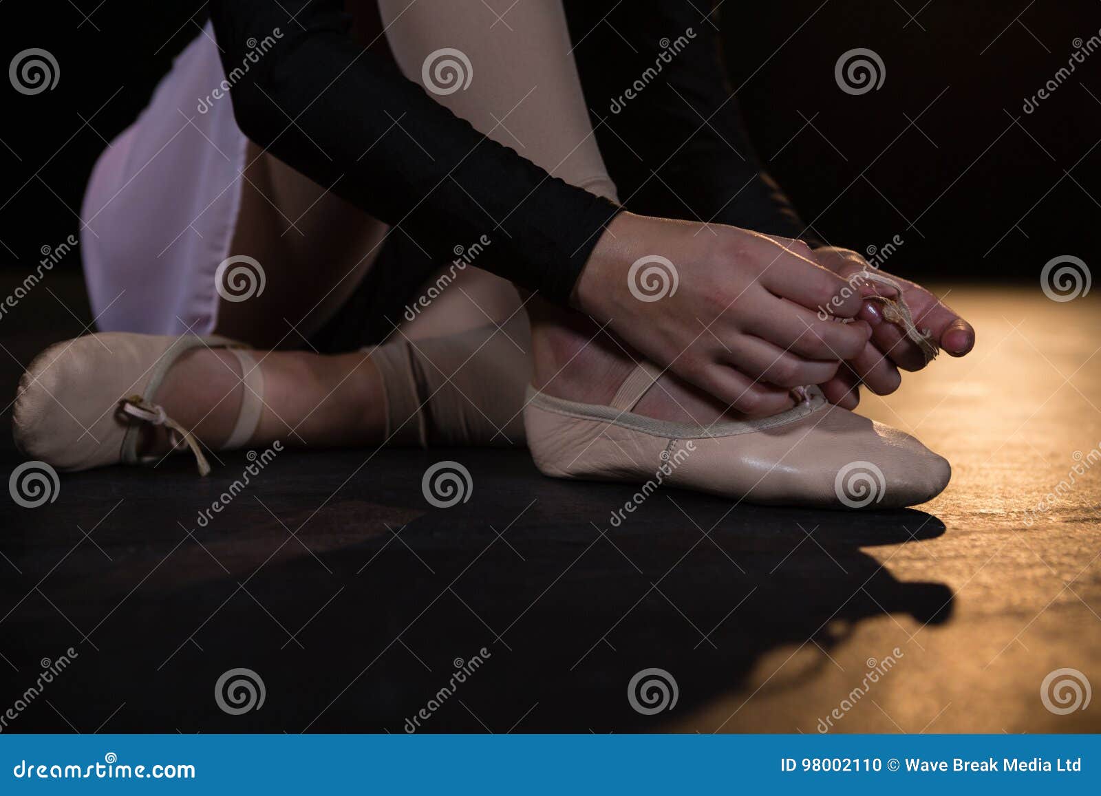 Ballerina tying her shoes stock photo. Image of flexibility - 98002110