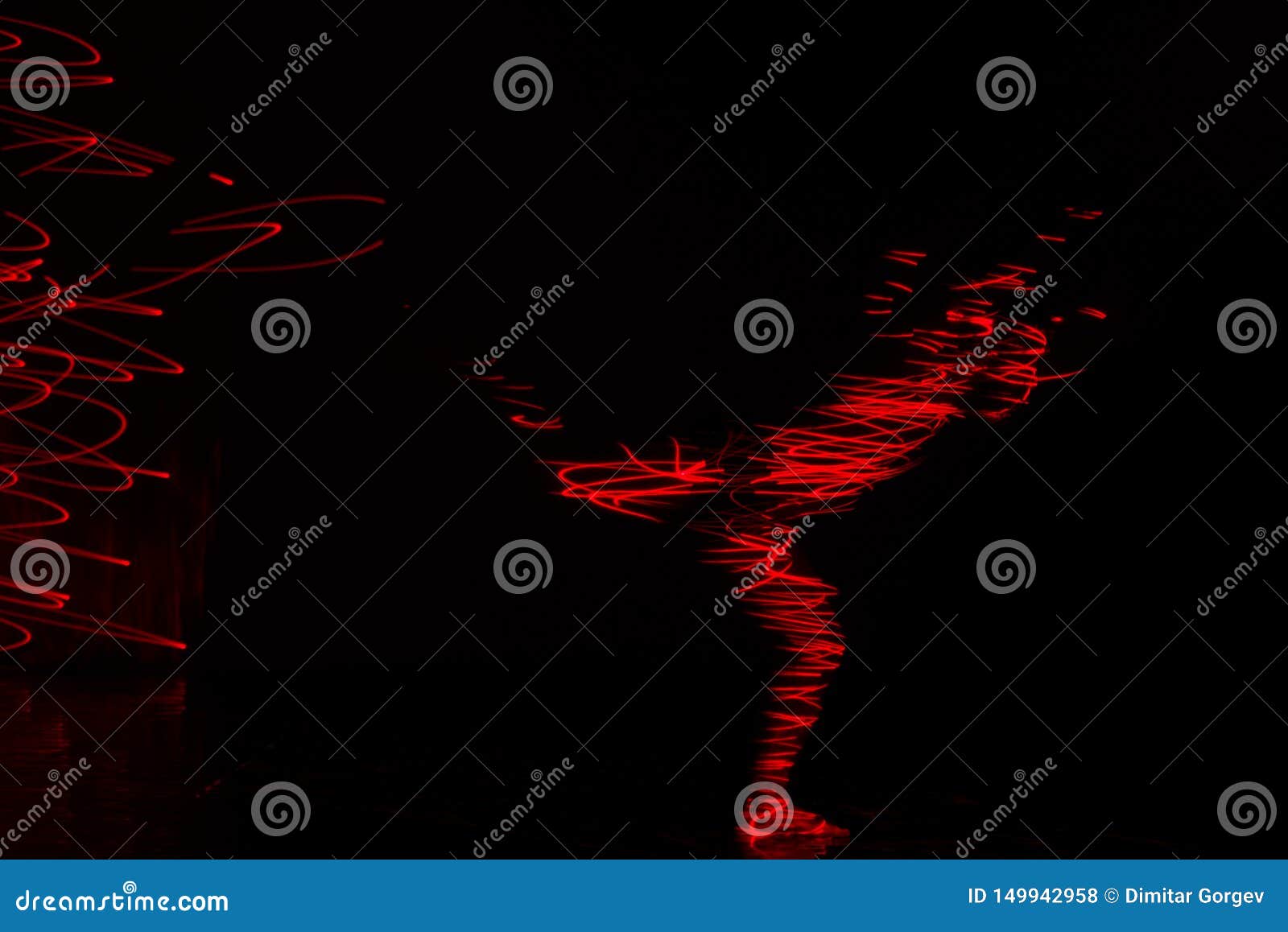 Ballet Dancer Dancing in Front of and Red Light while Expressing the ...