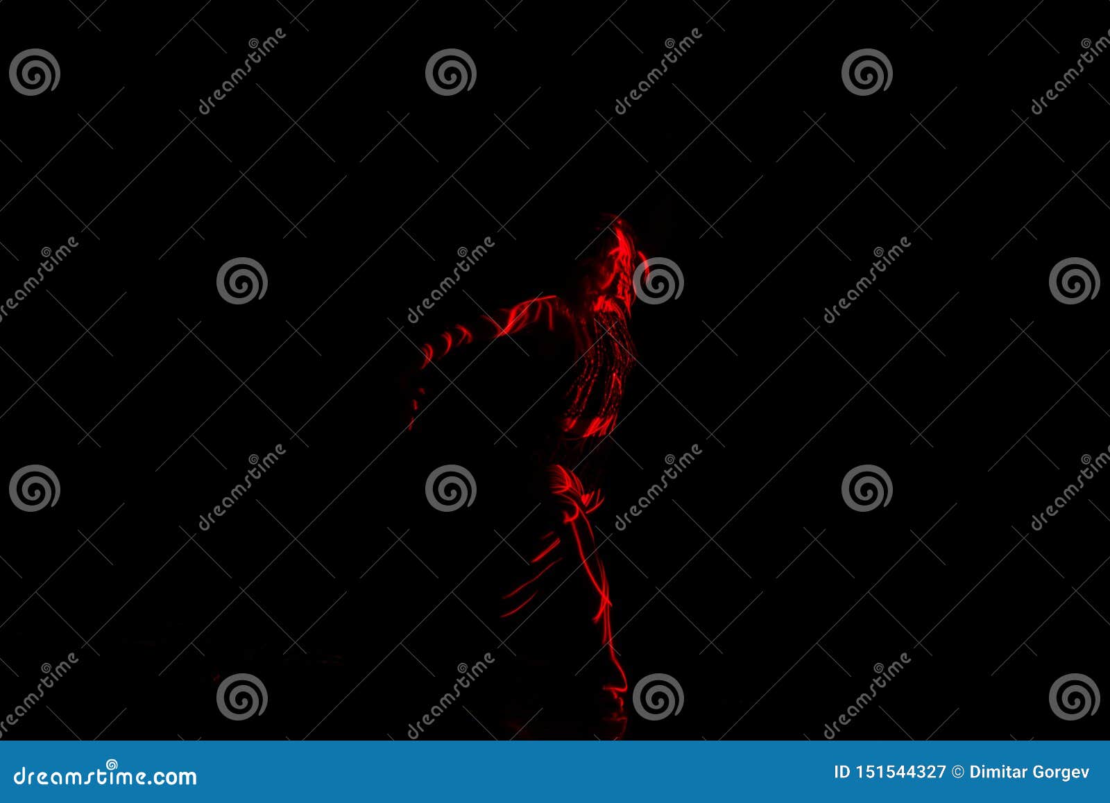 Ballet Dancer Dancing in Front of and Red Light while Expressing the ...