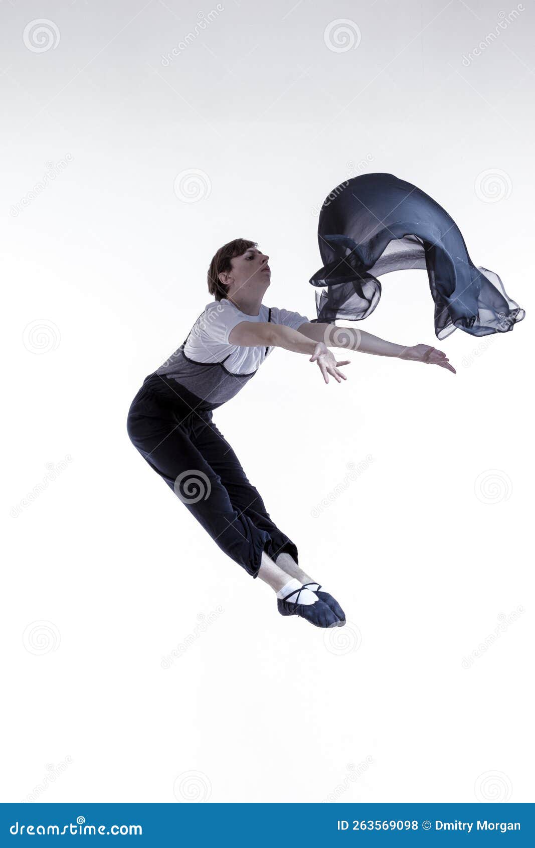 Ballet Dancer Performing in Flight with Hands Outspread in Studio Over ...