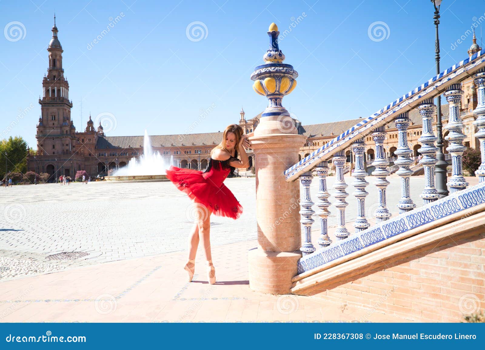 Ballet Dancer with Red Tutu Leaning on a Park Railing in Seville. the ...