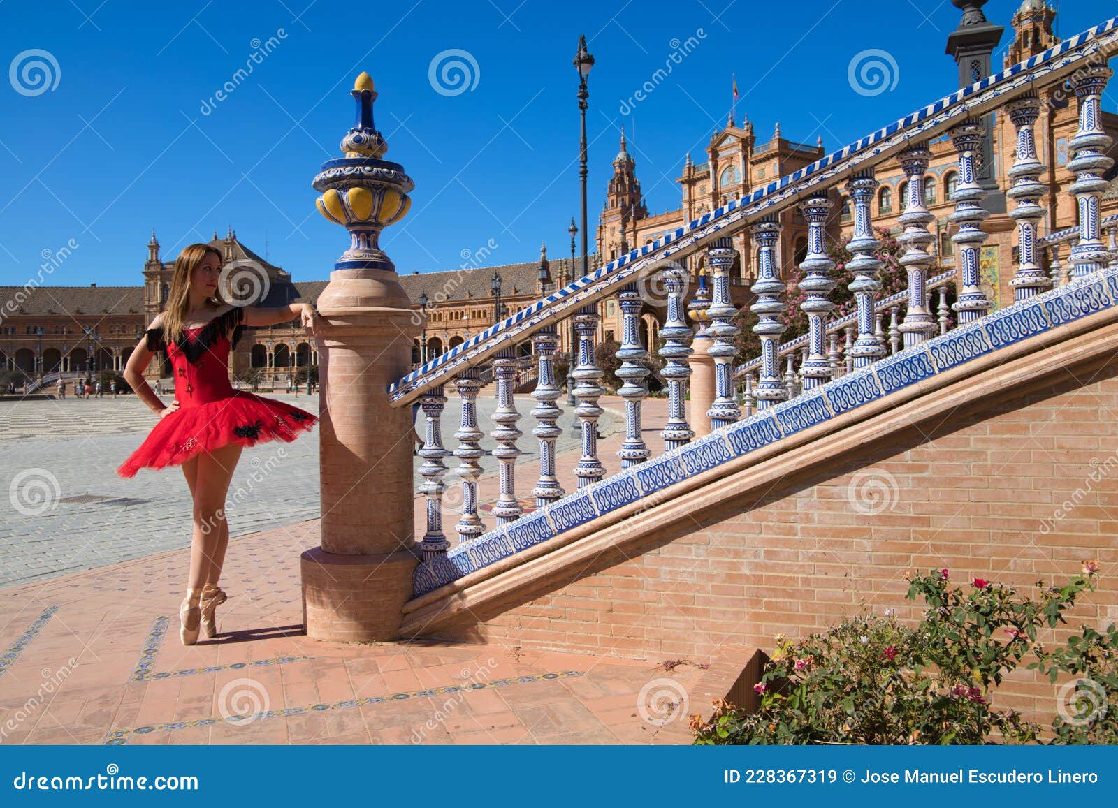 Ballet Dancer with Red Tutu Leaning on a Park Railing in Seville. the ...