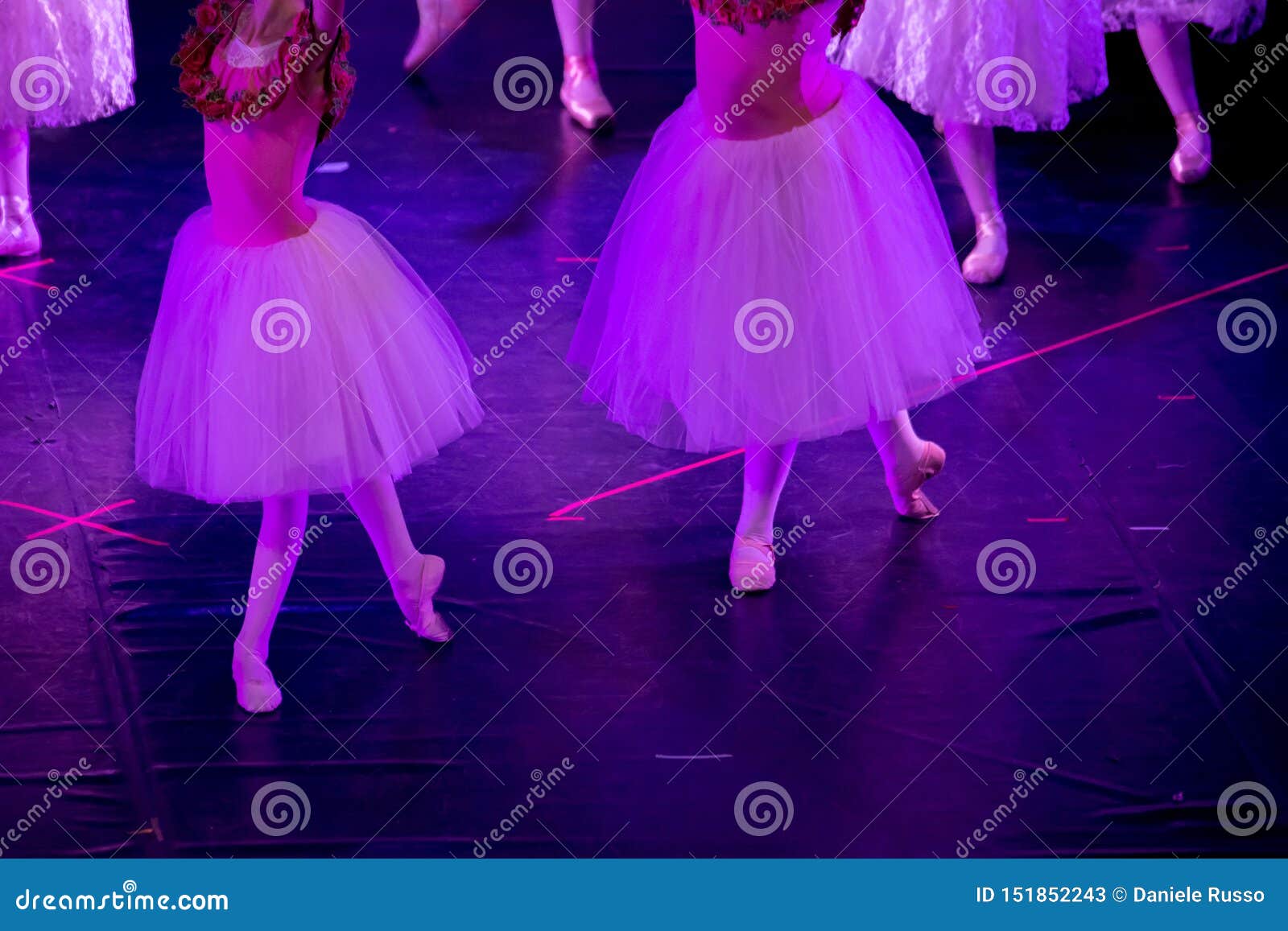 Ballet Dancers Under Purple Light with Classical Dresses Performing a ...