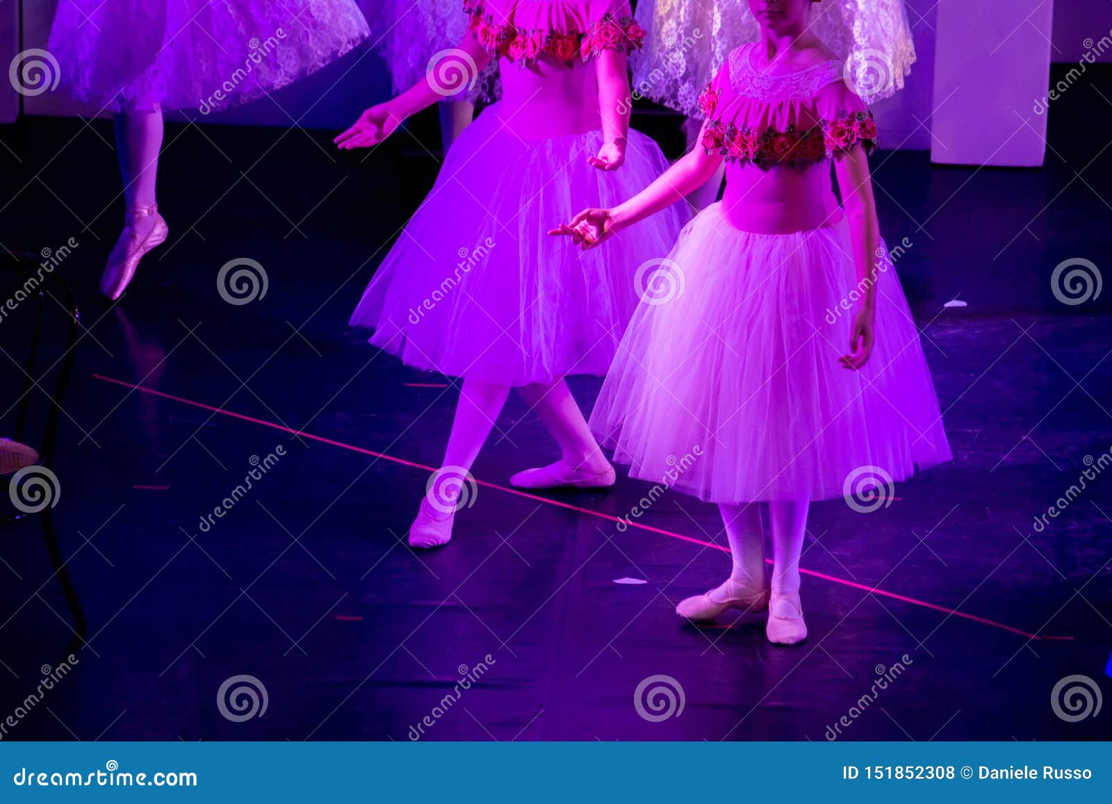 Ballet Dancers Under Purple Light with Classical Dresses Performing a ...