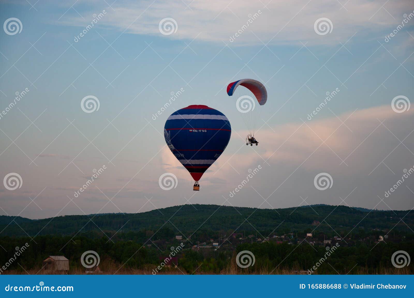 Balloon and Paraglider in the Evening Sky. Stock Photo - Image of ...