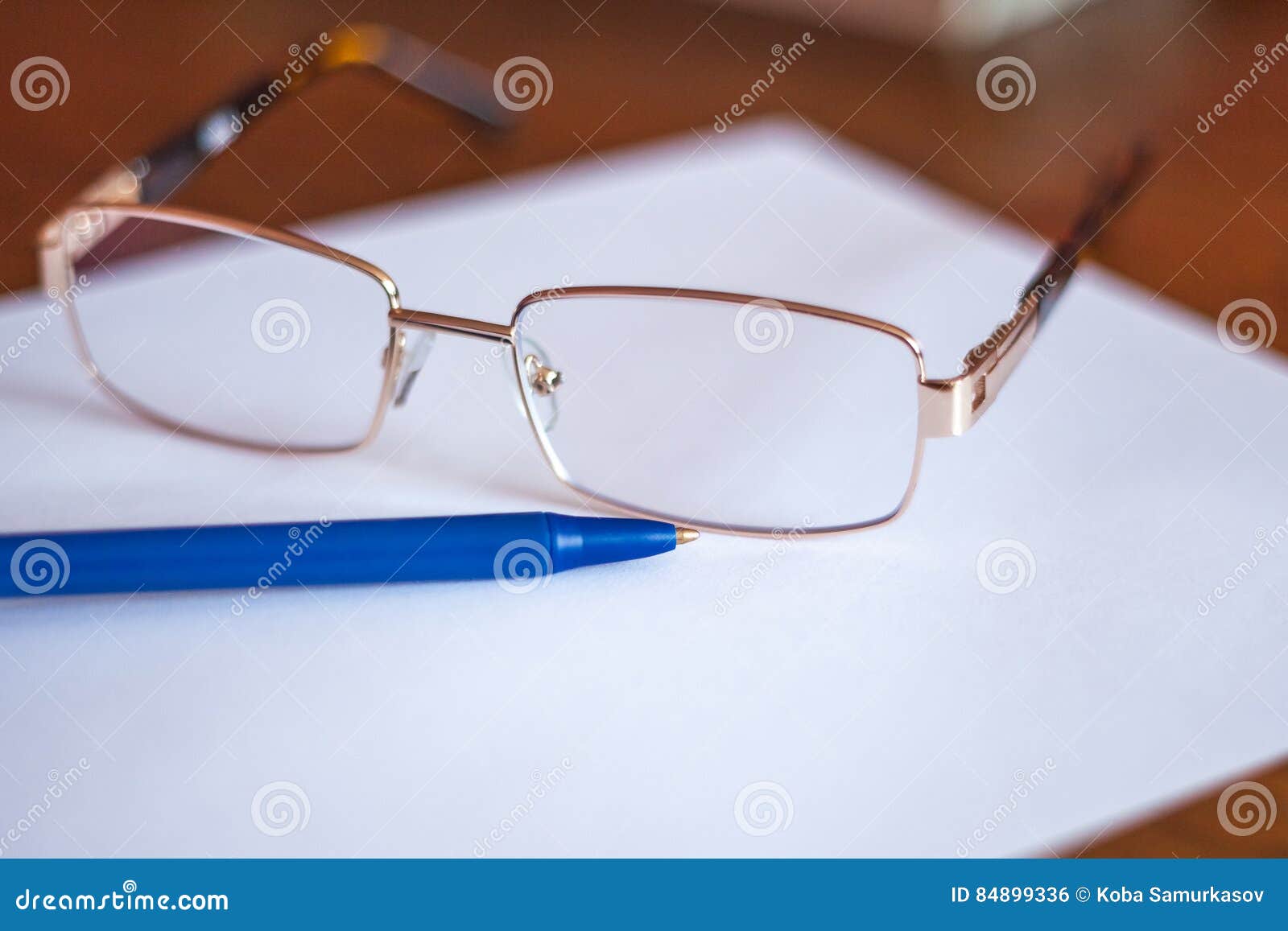 Ballpoint Pen on a Sheet and Reading Glasses Stock Photo - Image of ...