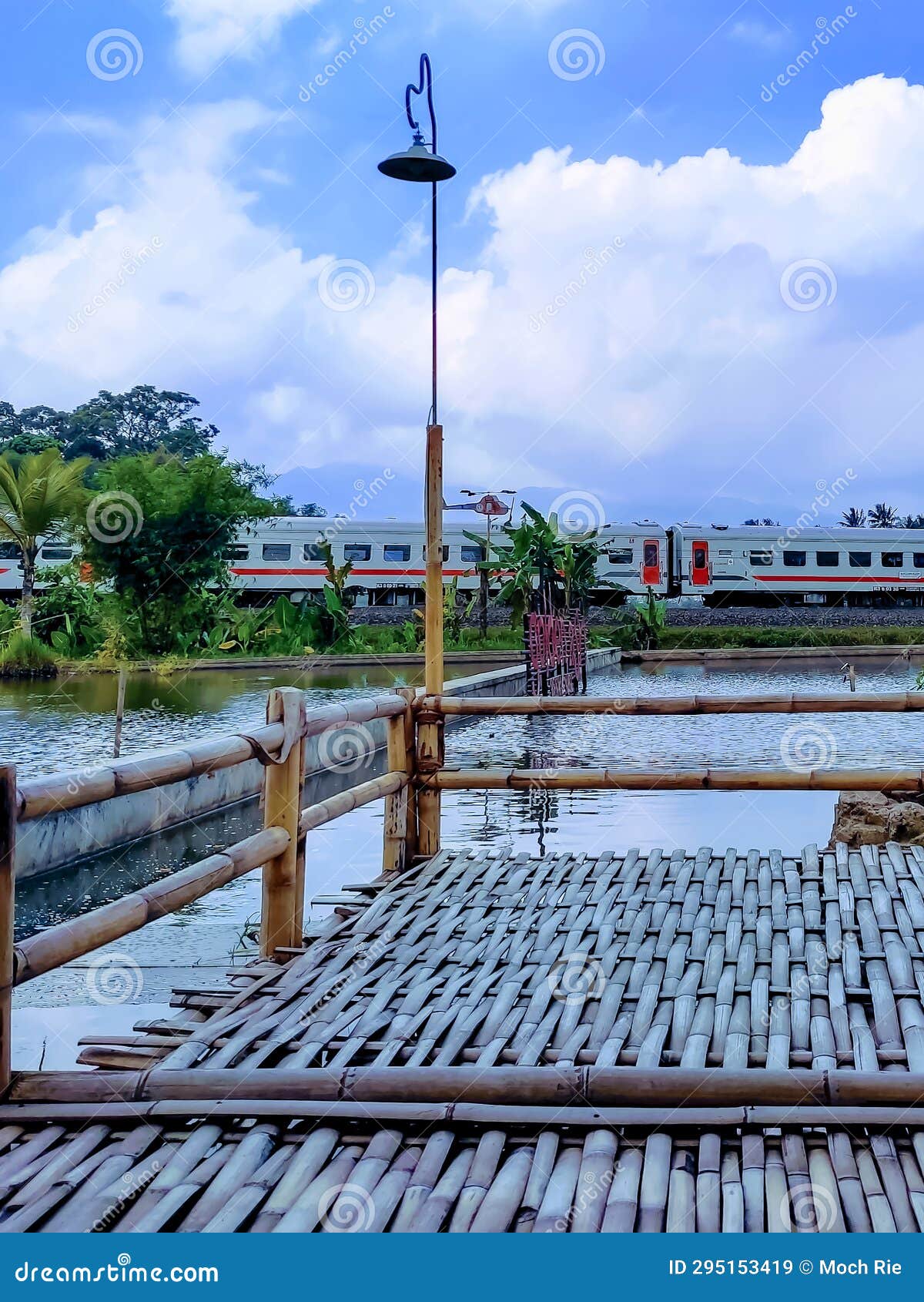Bamboo Lamp Post and Train Under Blue Sky with Rustic Bamboo Fence and ...