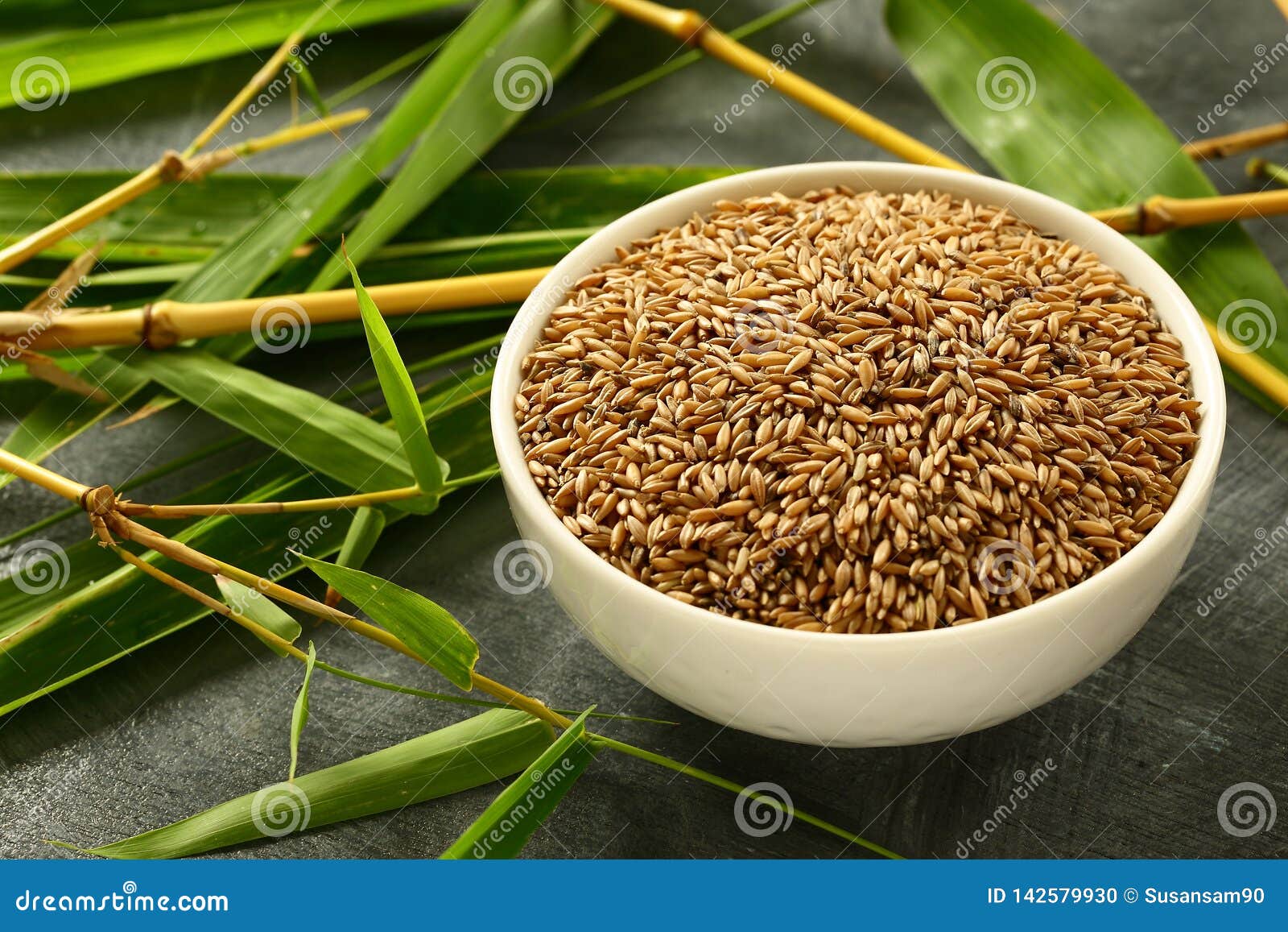 Bamboo rice grain in bowl stock photo. Image of branches - 142579930