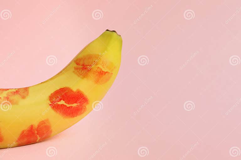 Banana Covered With Red Lipstick Marks On Light Pink Background Space For Text Potency Concept