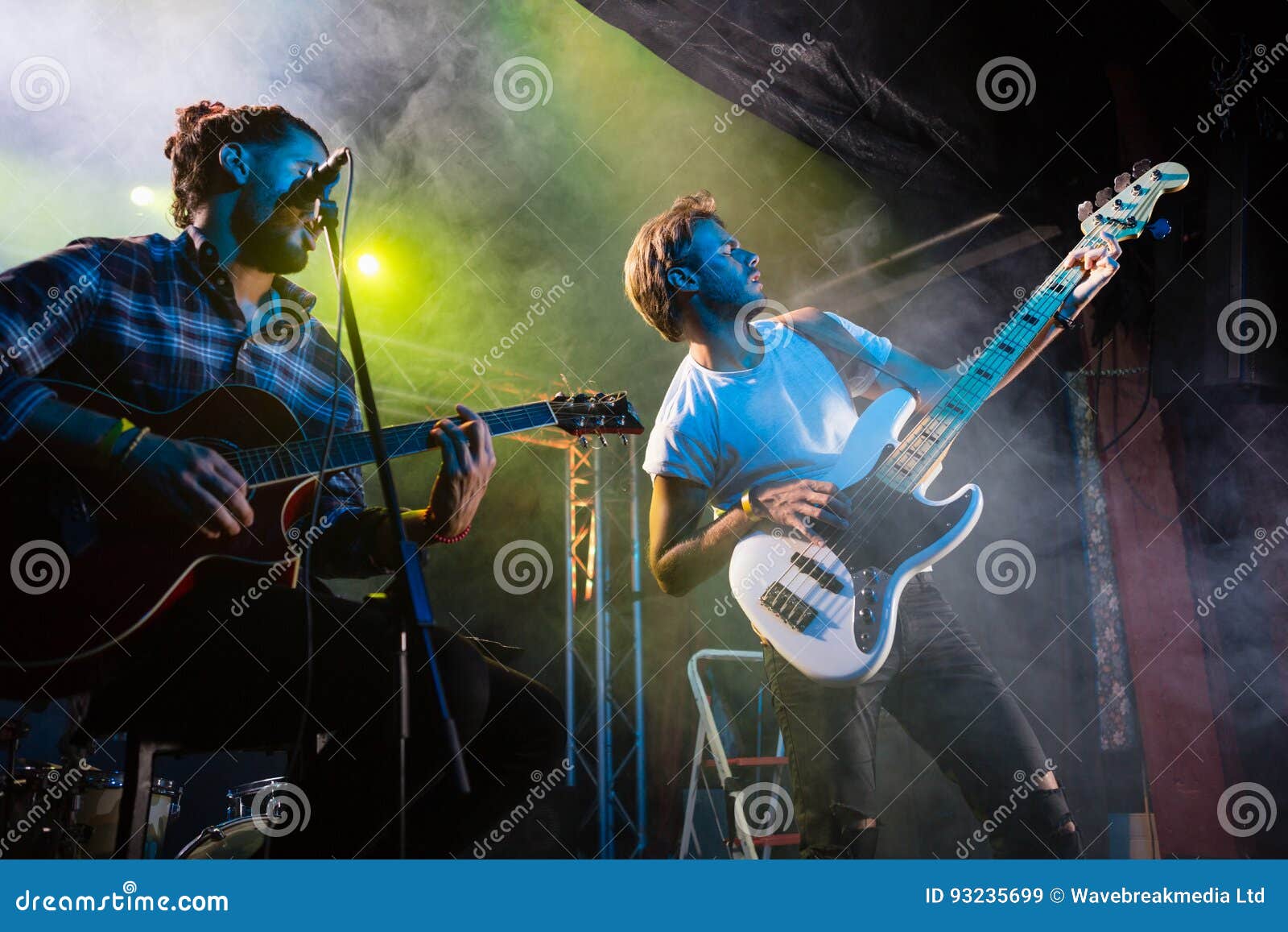 Band performing on stage stock image. Image of microphone - 93235699