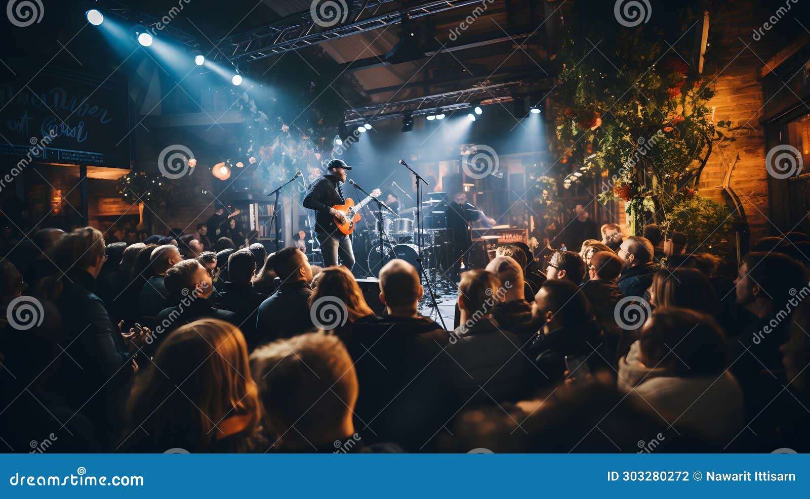 A Band in a Pub is Performing on Stage. with the Audience Surrounding ...