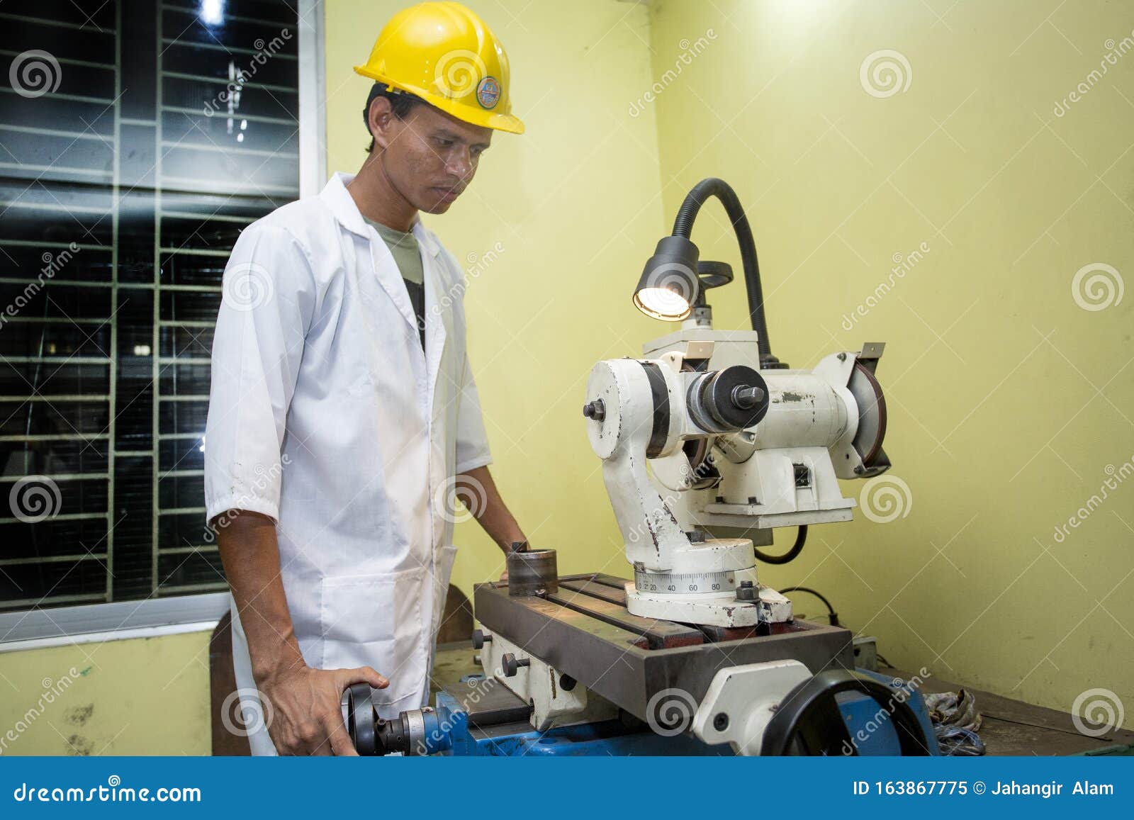 Bangladesh â€“ May 20, 2015: a Factory Lab Operator Using Steel Rod ...