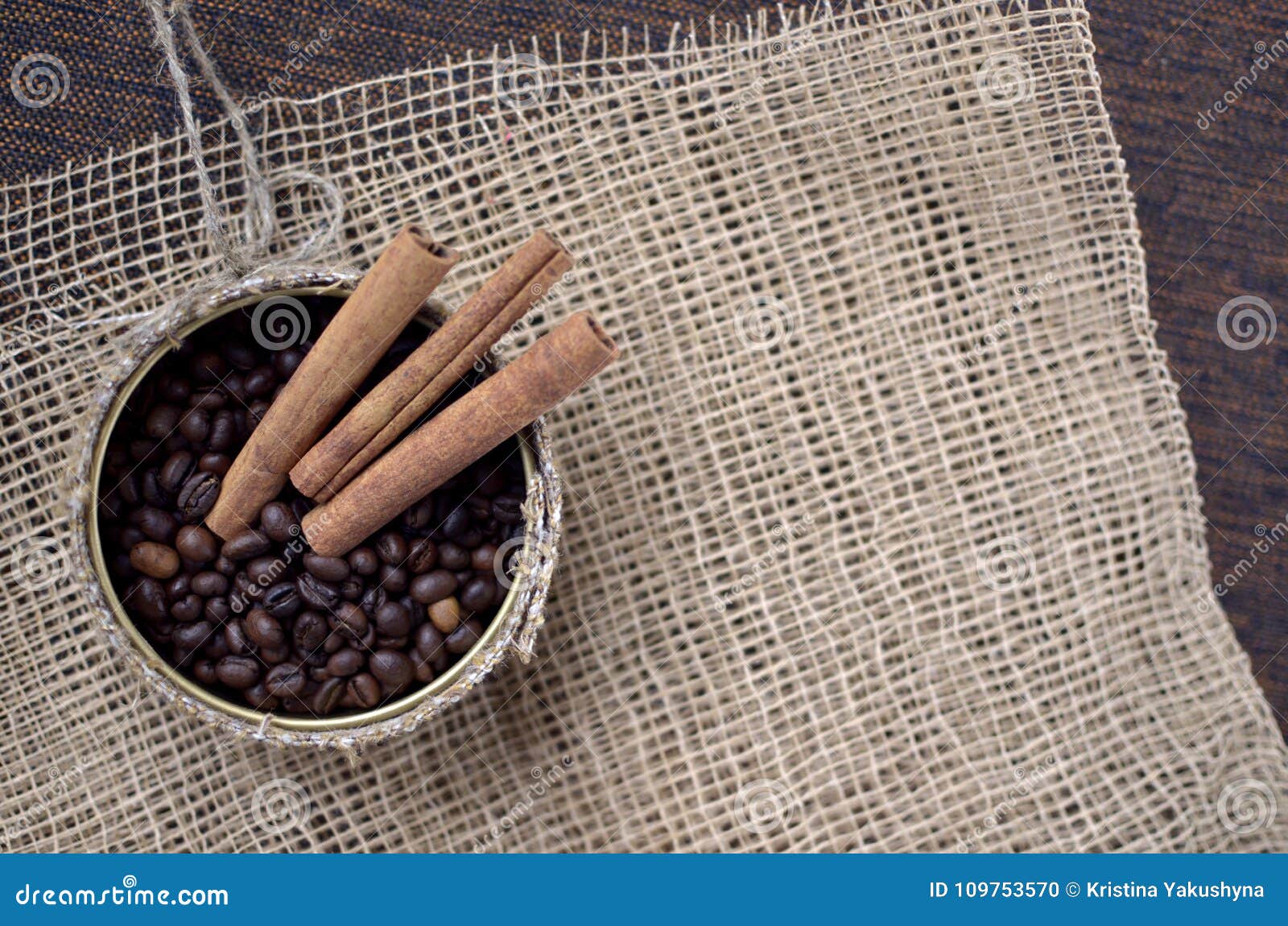 Bank with Coffee Beans and Cinnamon Sticks on the Table Stock Photo ...