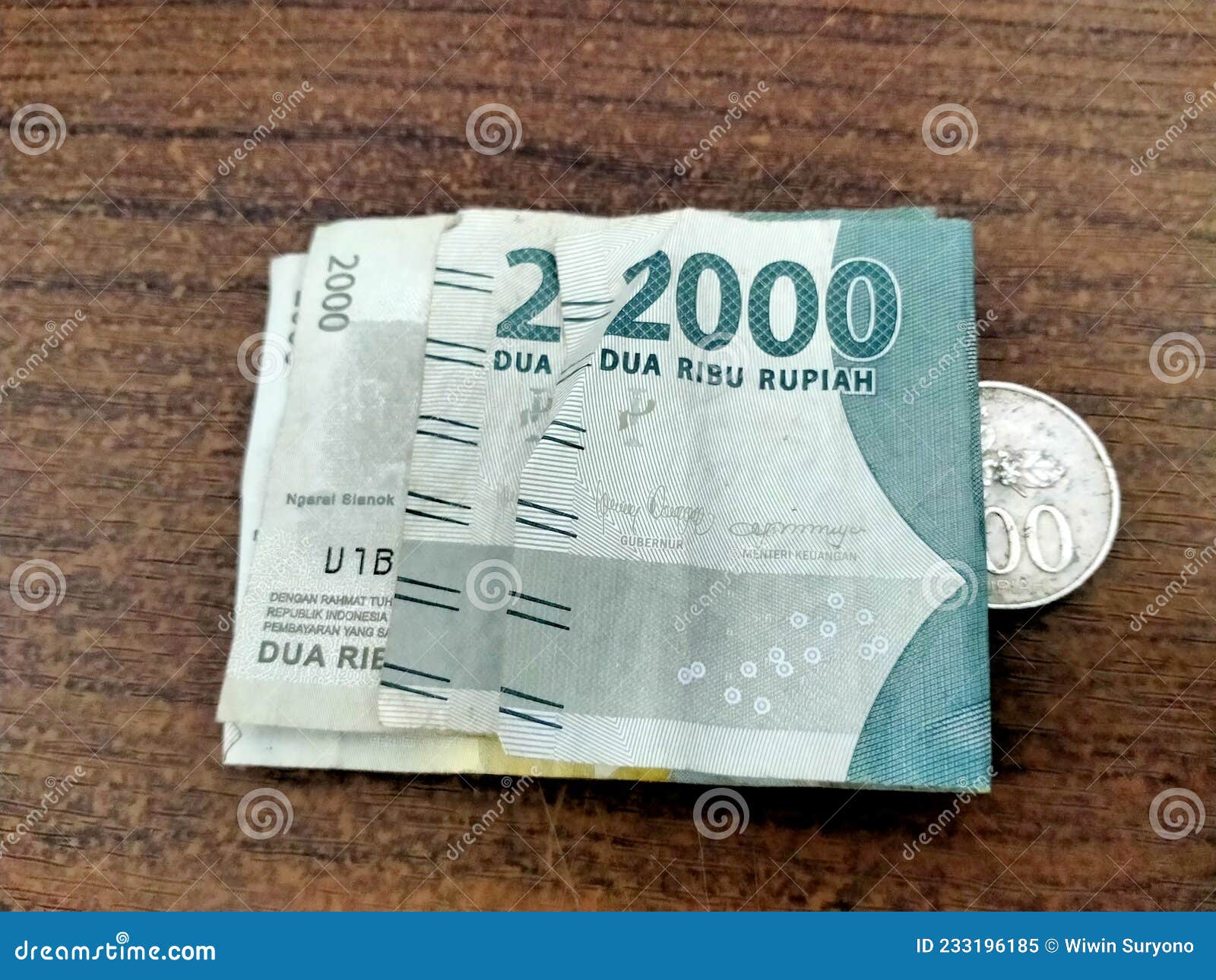The Banknote IDR 2,050 is Displaying on the Middle of Brown Table ...