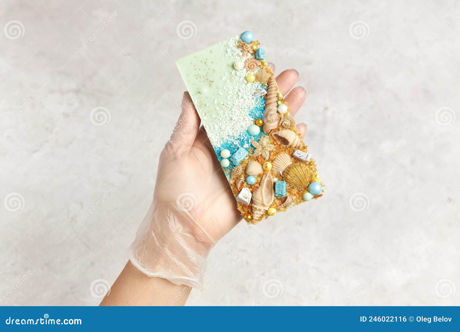 Bar of Chocolate Decorated with Sweets and Seashells in the Hand of ...