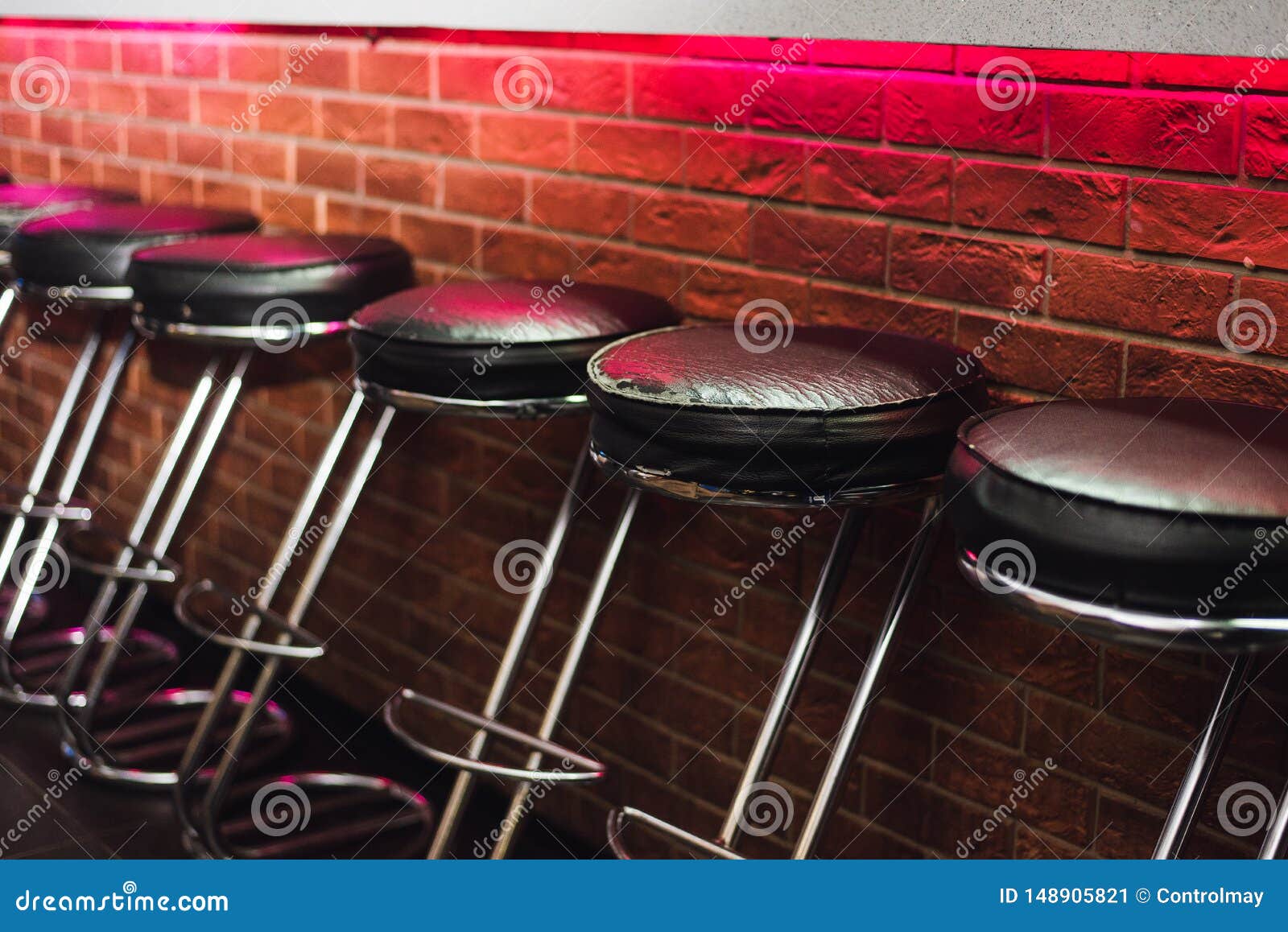 Bar Stools at the Counter in Neon Light. Leather Chairs at the Bar in ...