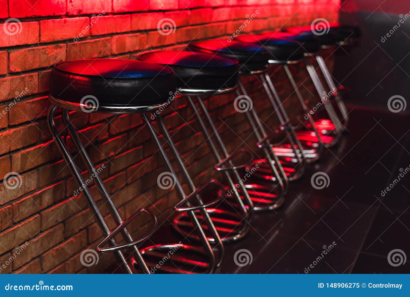 Bar Stools at the Counter in Neon Light. Leather Chairs at the Bar in ...