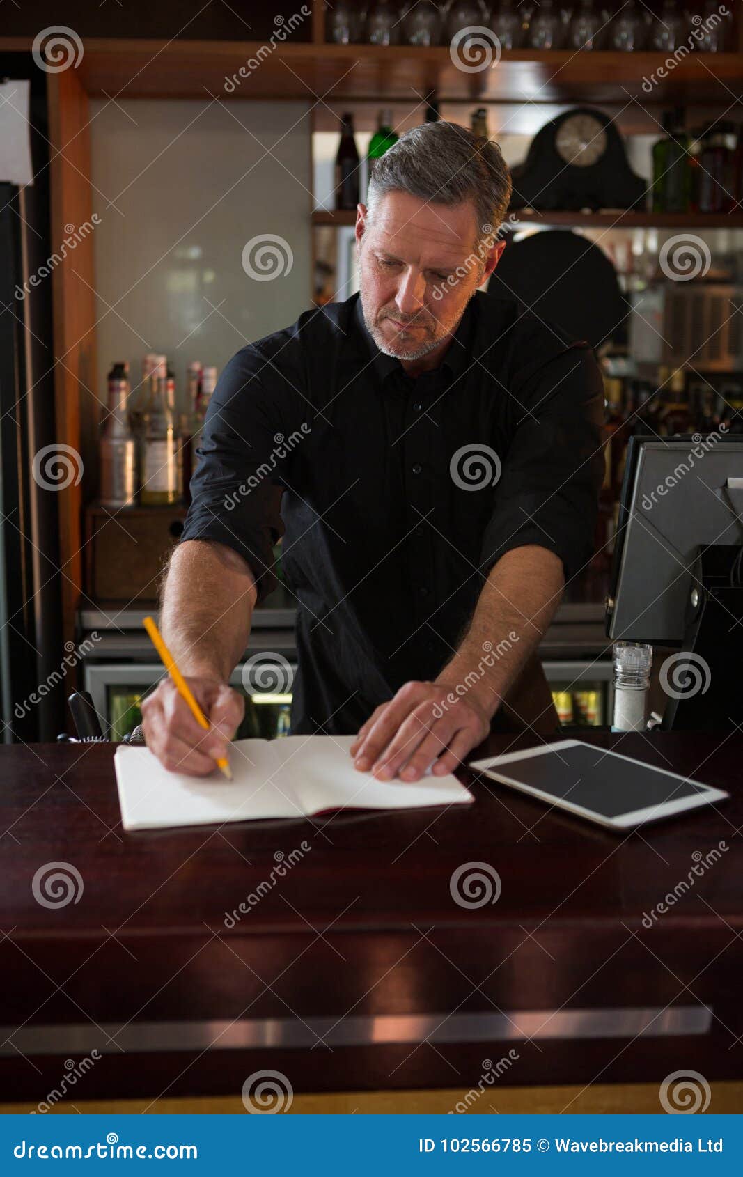 Bar Tender Writing in a Book Stock Image - Image of business ...