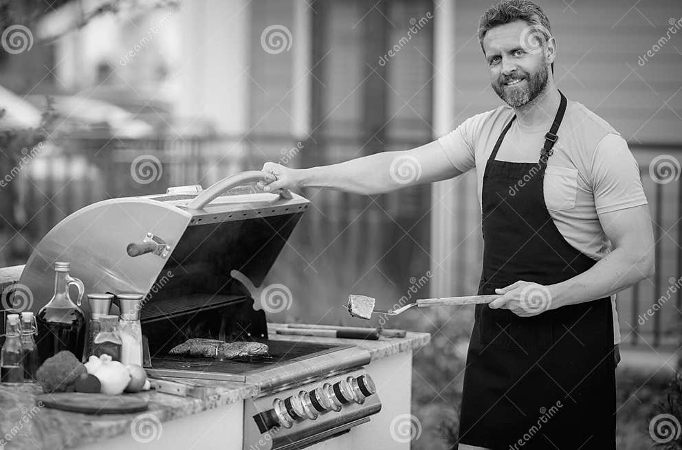 Barbecue Concept. Middle Aged Hispanic Man in Apron for Barbecue ... Barbecue Concept. Middle Aged Hispanic Man in Apron for Barbecue ...