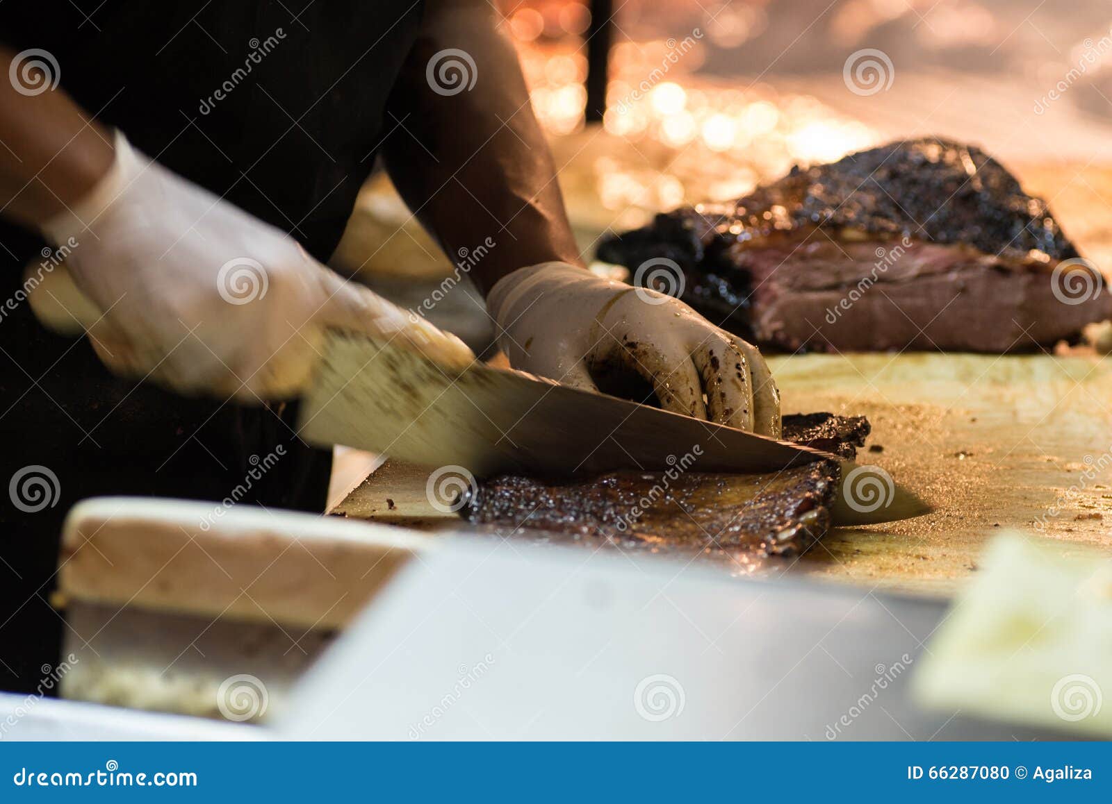 Barbecue Pitmaster Cutting through a Slab or Pork Ribs with a Br Stock ...