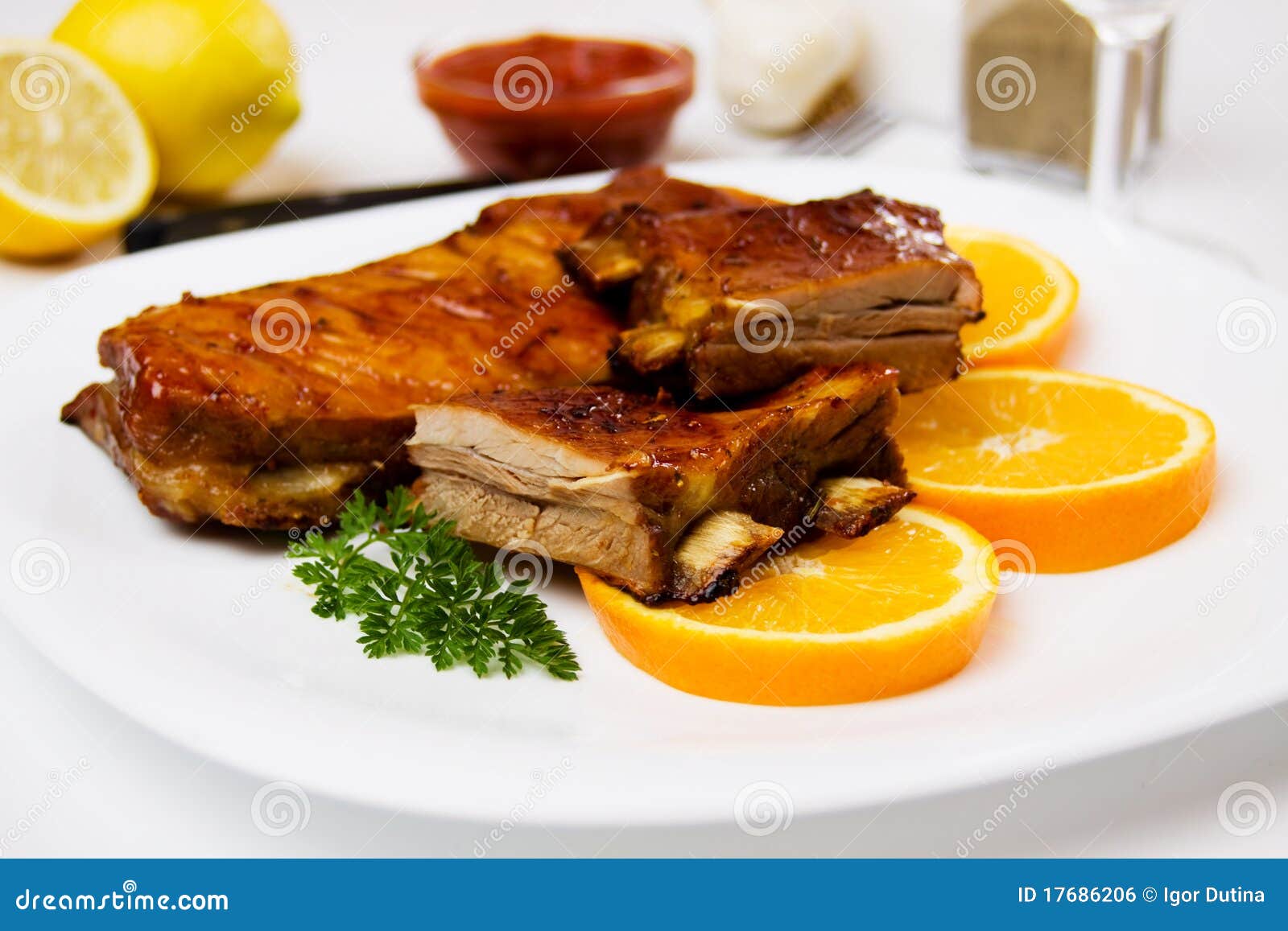 Barbecued Ribs with Orange Slices Stock Photo - Image of plate, glazed ...