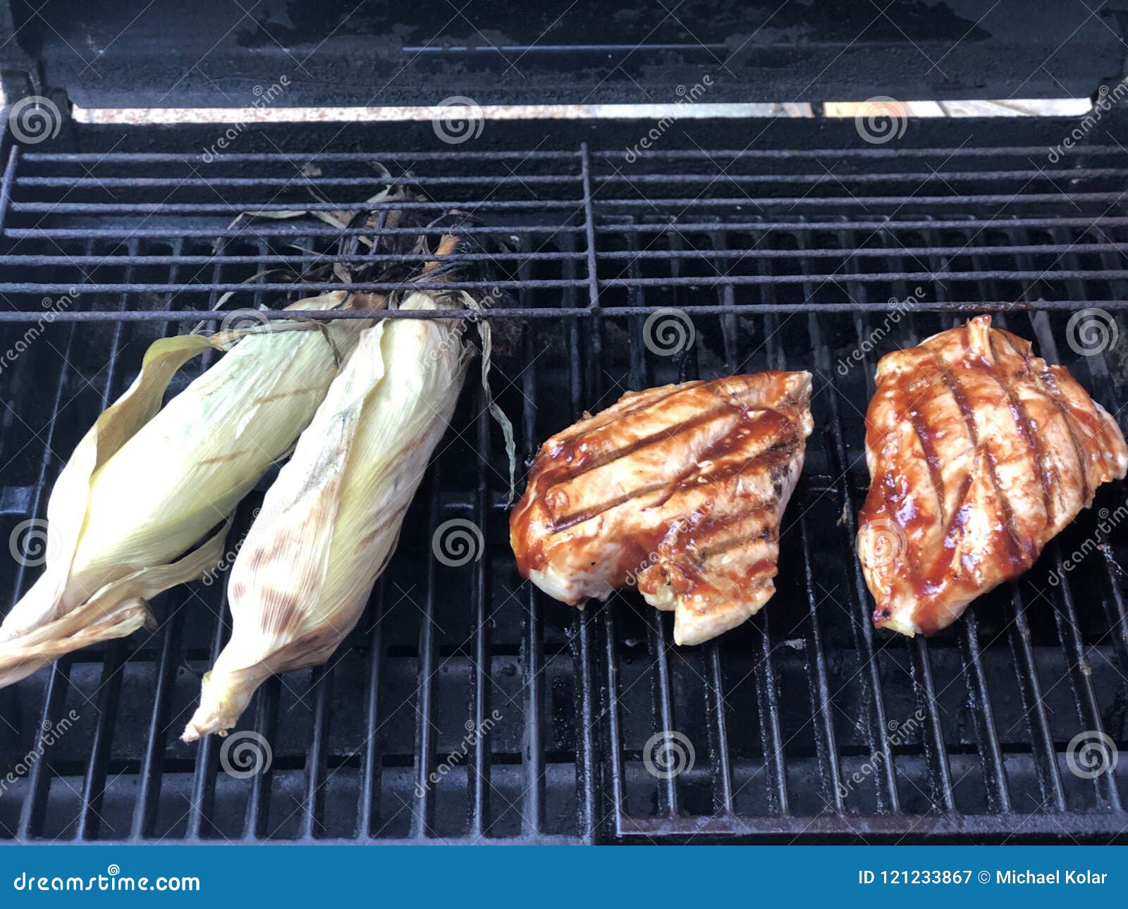 Barbecuing corn an chicken stock image. Image of backyard - 121233867