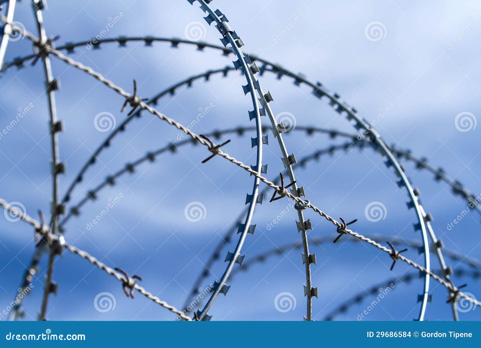 Barbed and Razor Wire Fence Stock Photo - Image of barbed, blue: 29686584