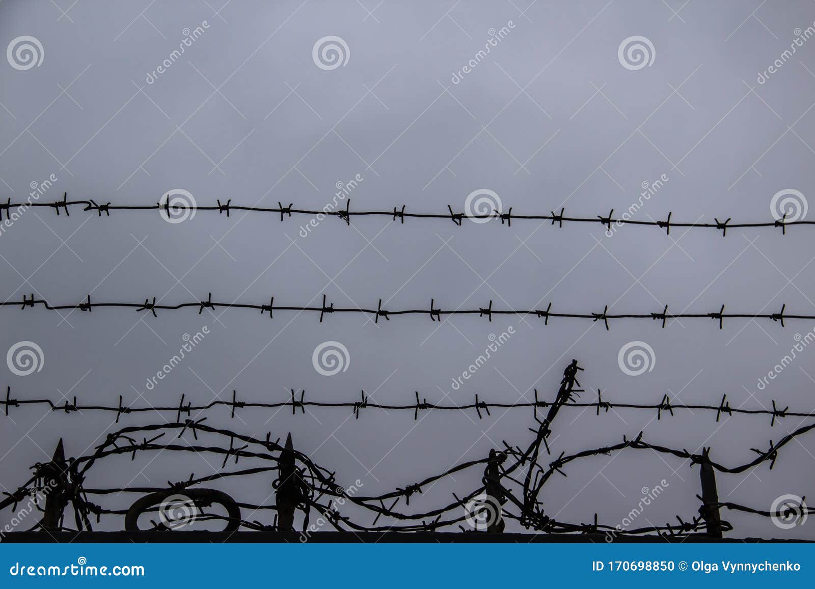 Barbed Wire Fence on Against Grey Sky Background Stock Photo - Image of ...
