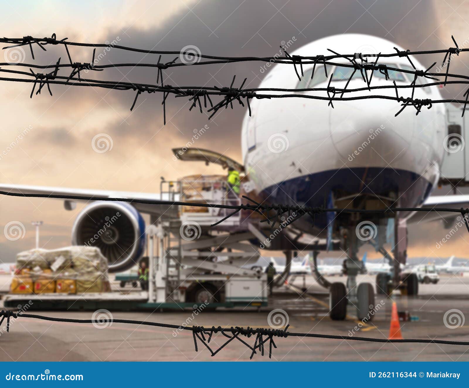 Barbed Wire Fence in Front of Loading Cargo on Plane in Airport Stock ...
