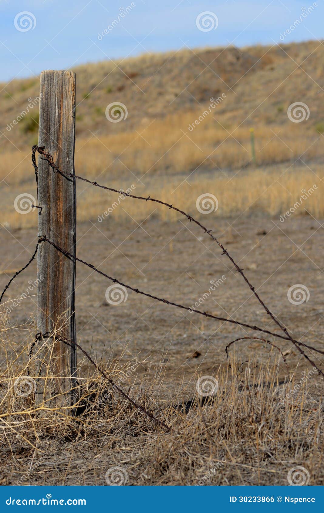 Barbed Wire and Fence Post with Wild Prairie Background Stock Photo ...