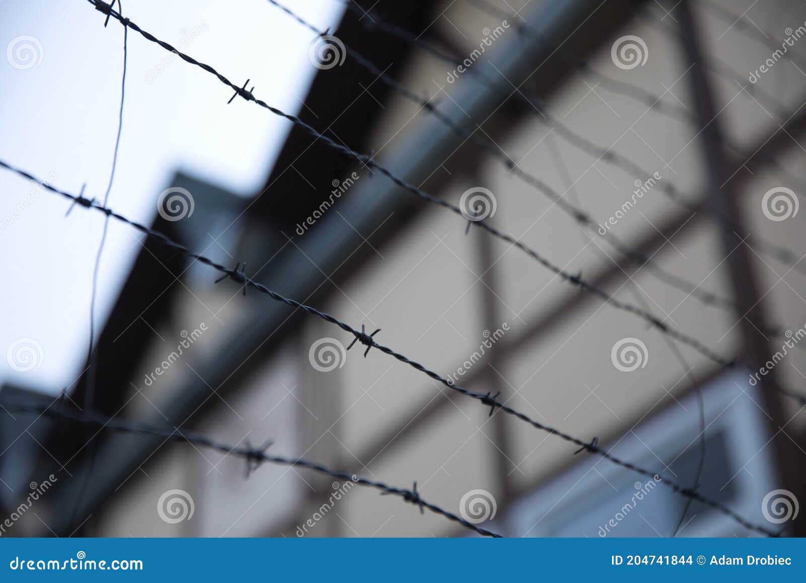Barbed Wire Fence Strings with House in Background Stock Photo - Image ...