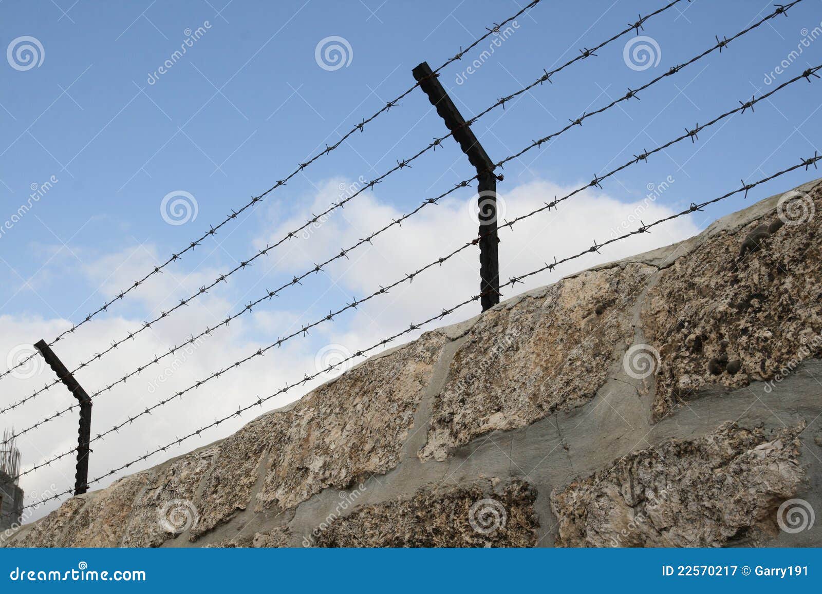 Barbed Wire Over the Stone Wall Stock Image - Image of wall, clouds ...