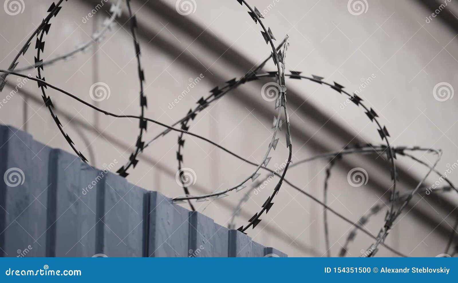 Barbed wire on prison wall stock footage. Video of criminal - 154351500