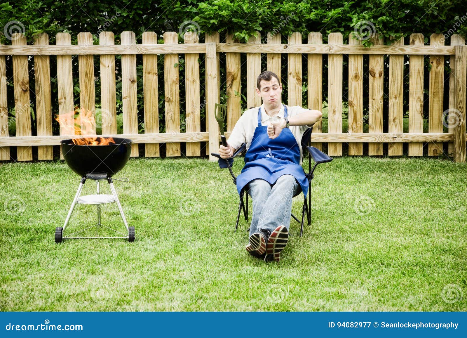 Barbeque: Man Checks Time on Watch Stock Image - Image of yard, time ...