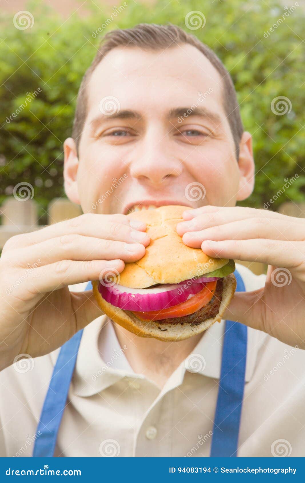 Barbeque: Man Eating a Hamburger Stock Photo - Image of hamburger ...
