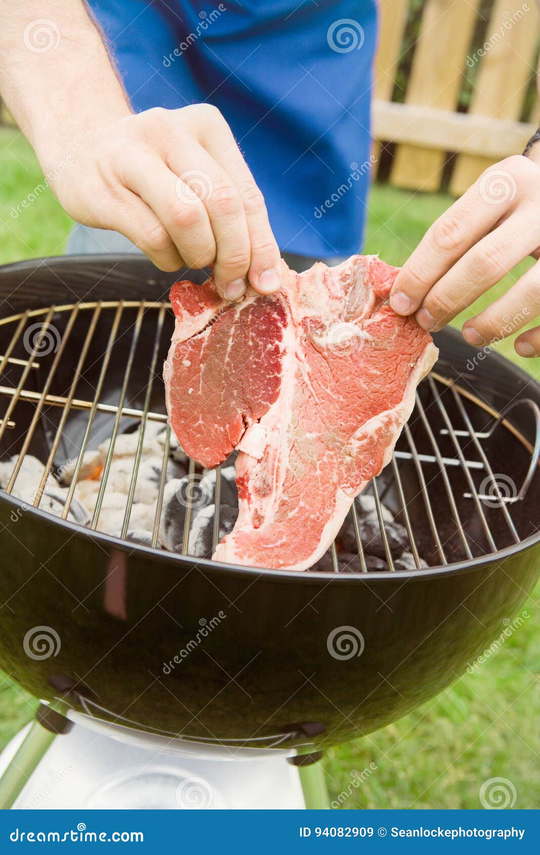Barbeque: Man Laying T-Bone Steak on Grill Stock Image - Image of ...