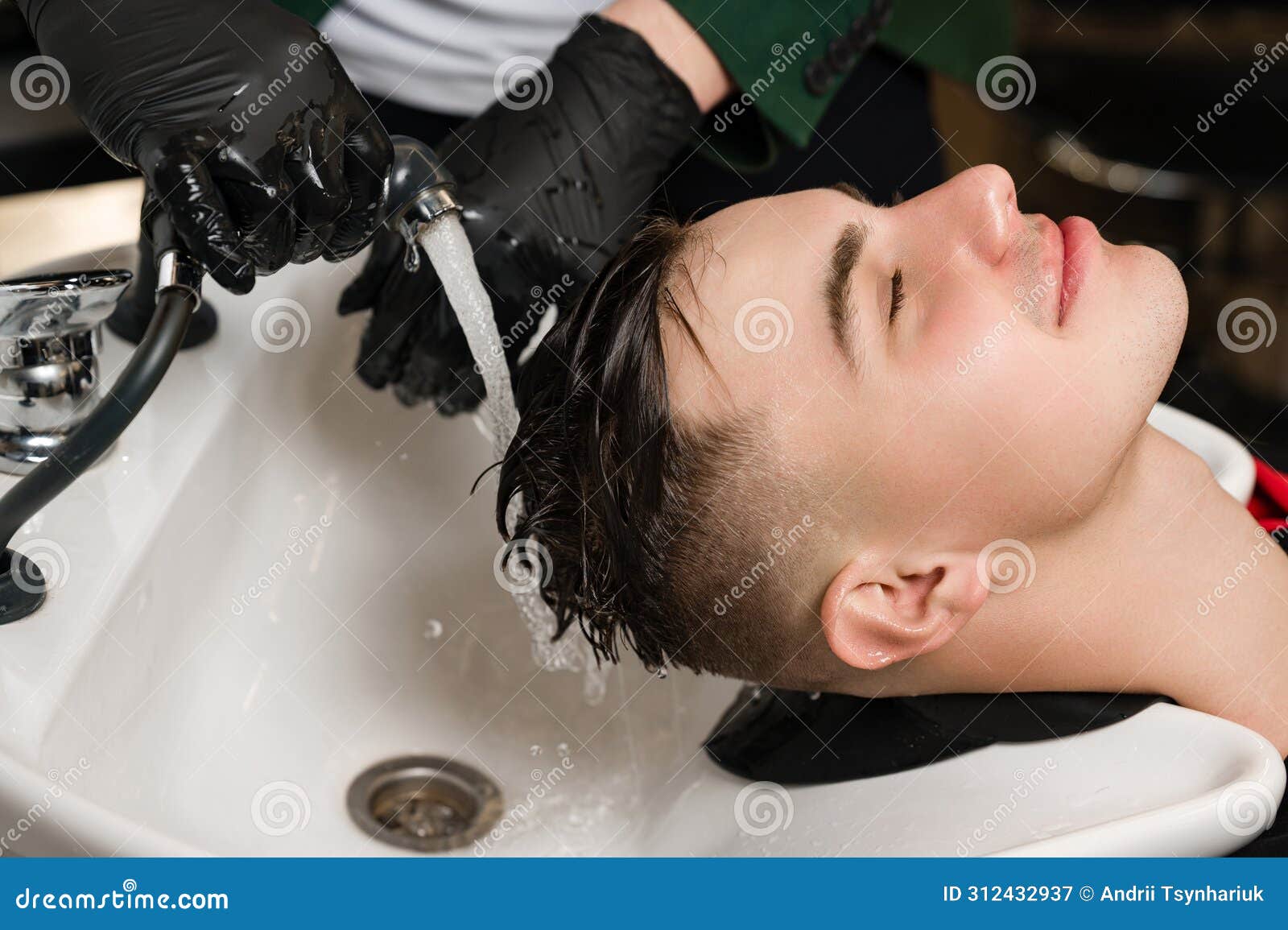 Barber Shampooing Washing a Male Clients Head in the Sink. Stock Image ...