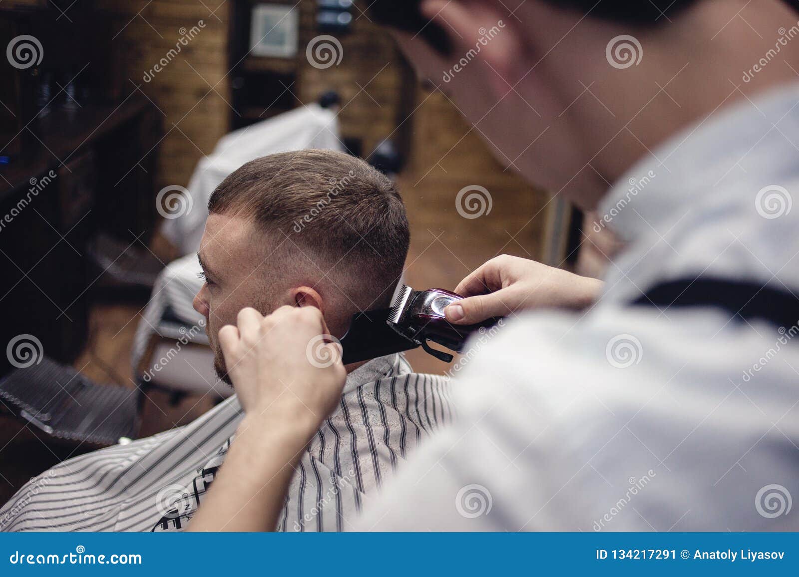 Barber Shaves the Client`s Head with a Shaving Machine Stock Image ...