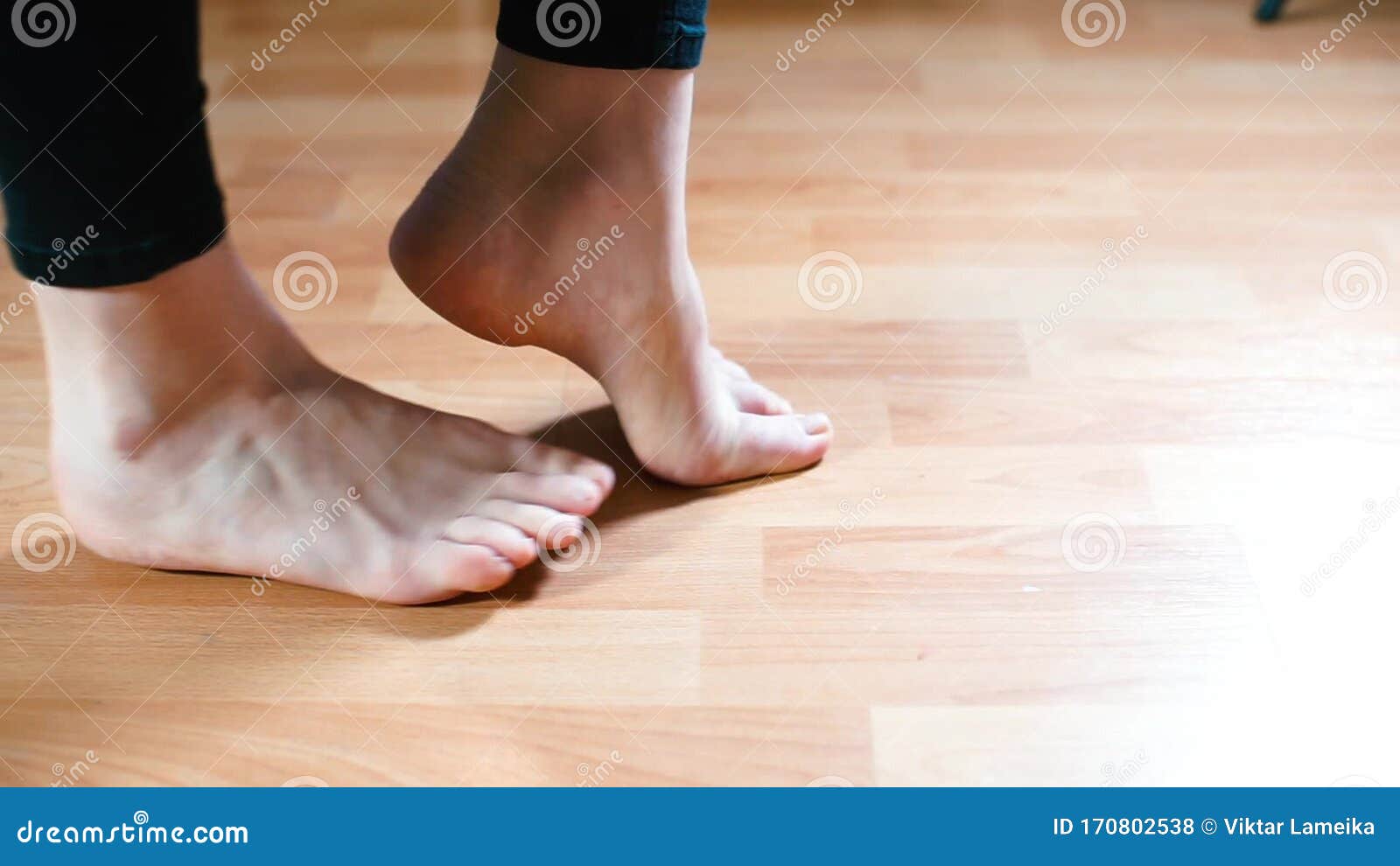 The Bare Feet of a Dancer Doing a Dance Move with Her Legs on a ...